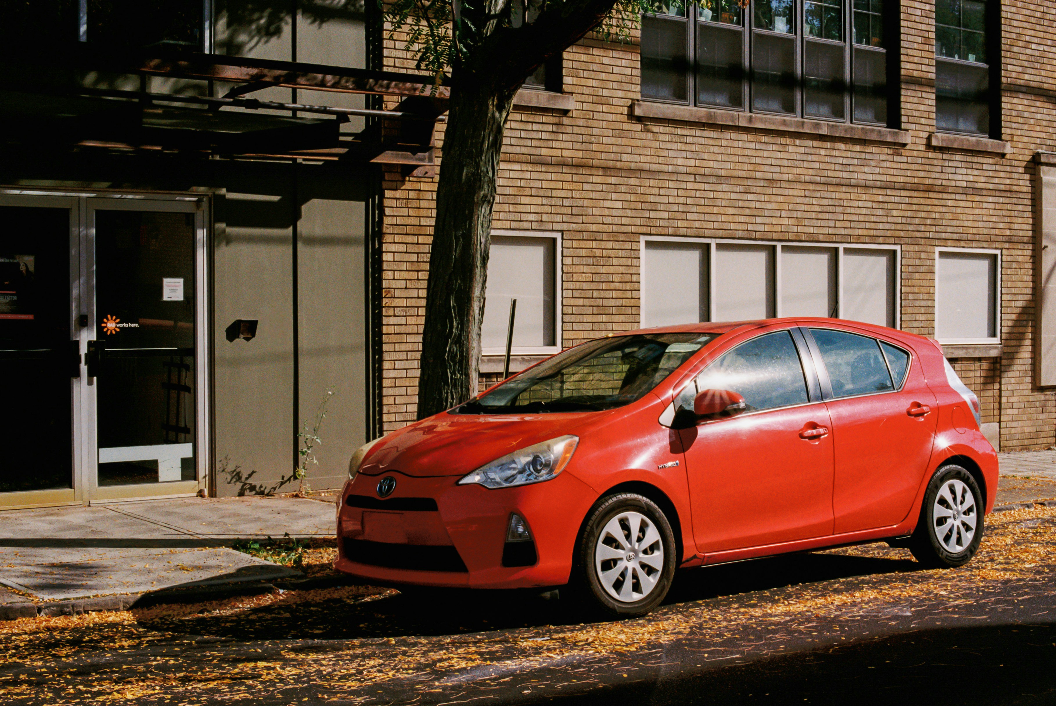 A small red car parked in front of a building photo – Free Pittsburgh ...