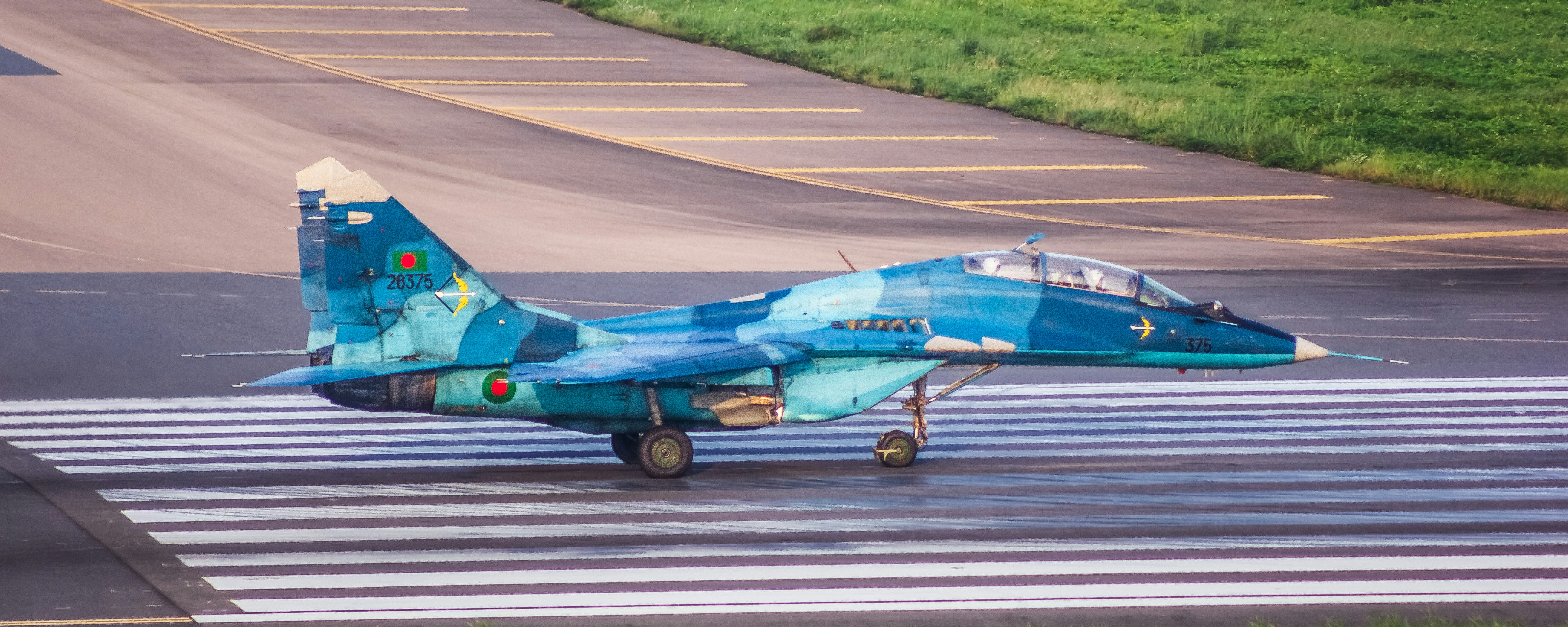 A blue fighter jet sitting on top of an airport tarmac photo – Free ...