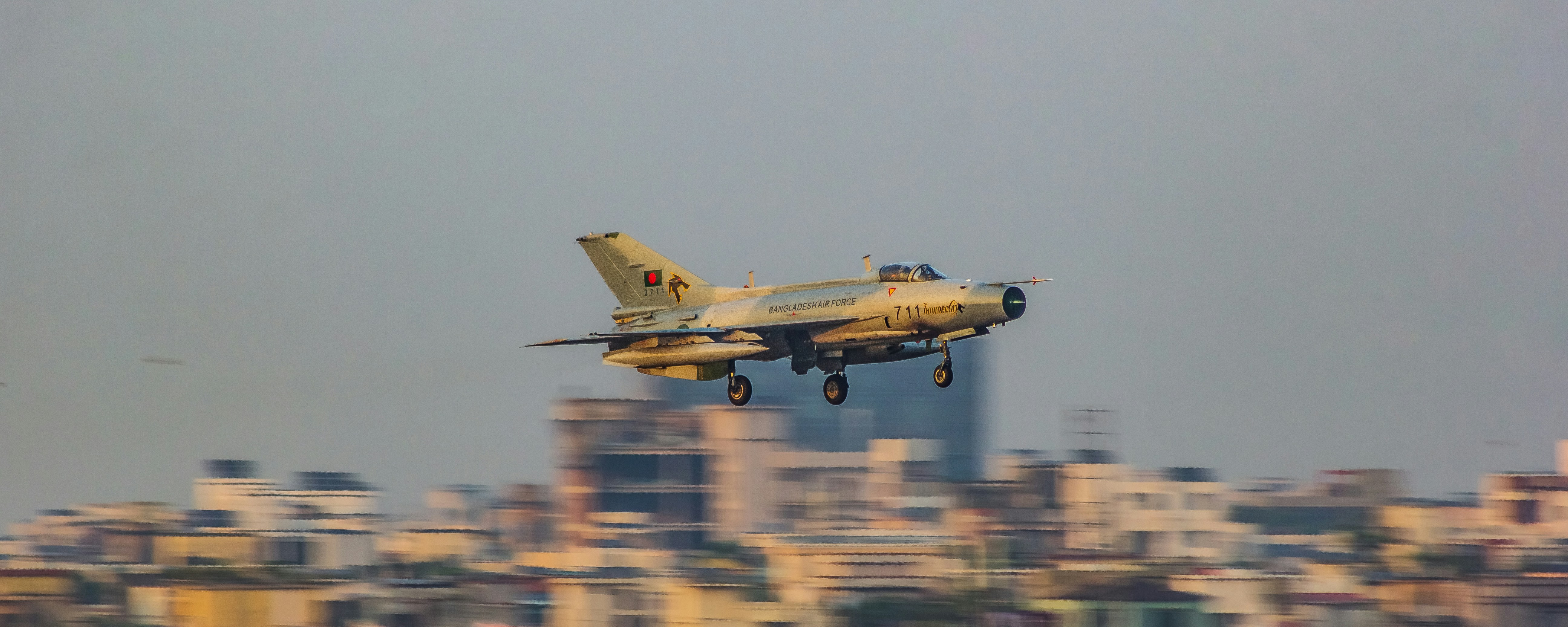 Low-Altitude Jet Slices Through a Blurred Urban Horizon