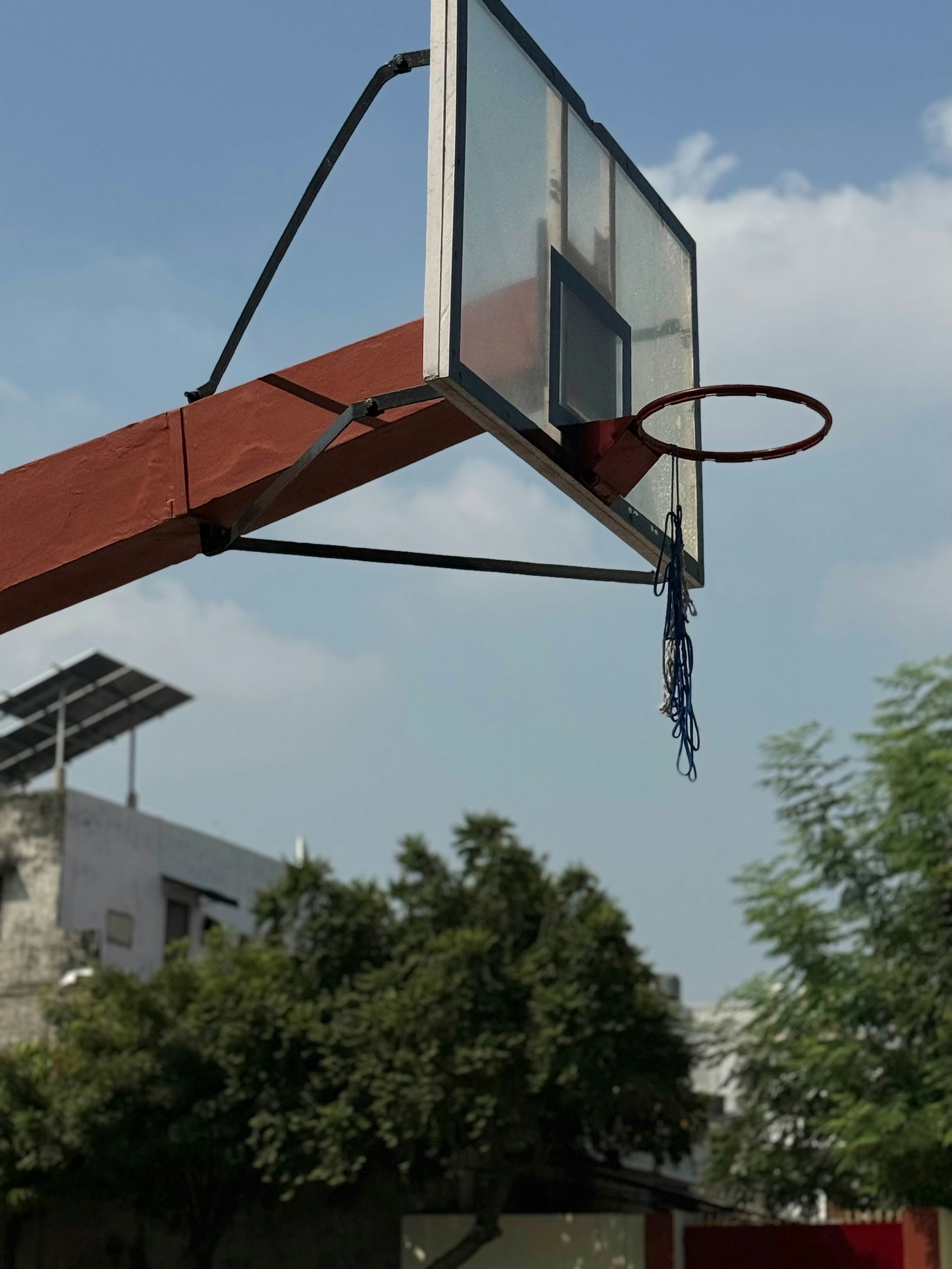 A basketball hoop hanging from the side of a building photo – Free ...