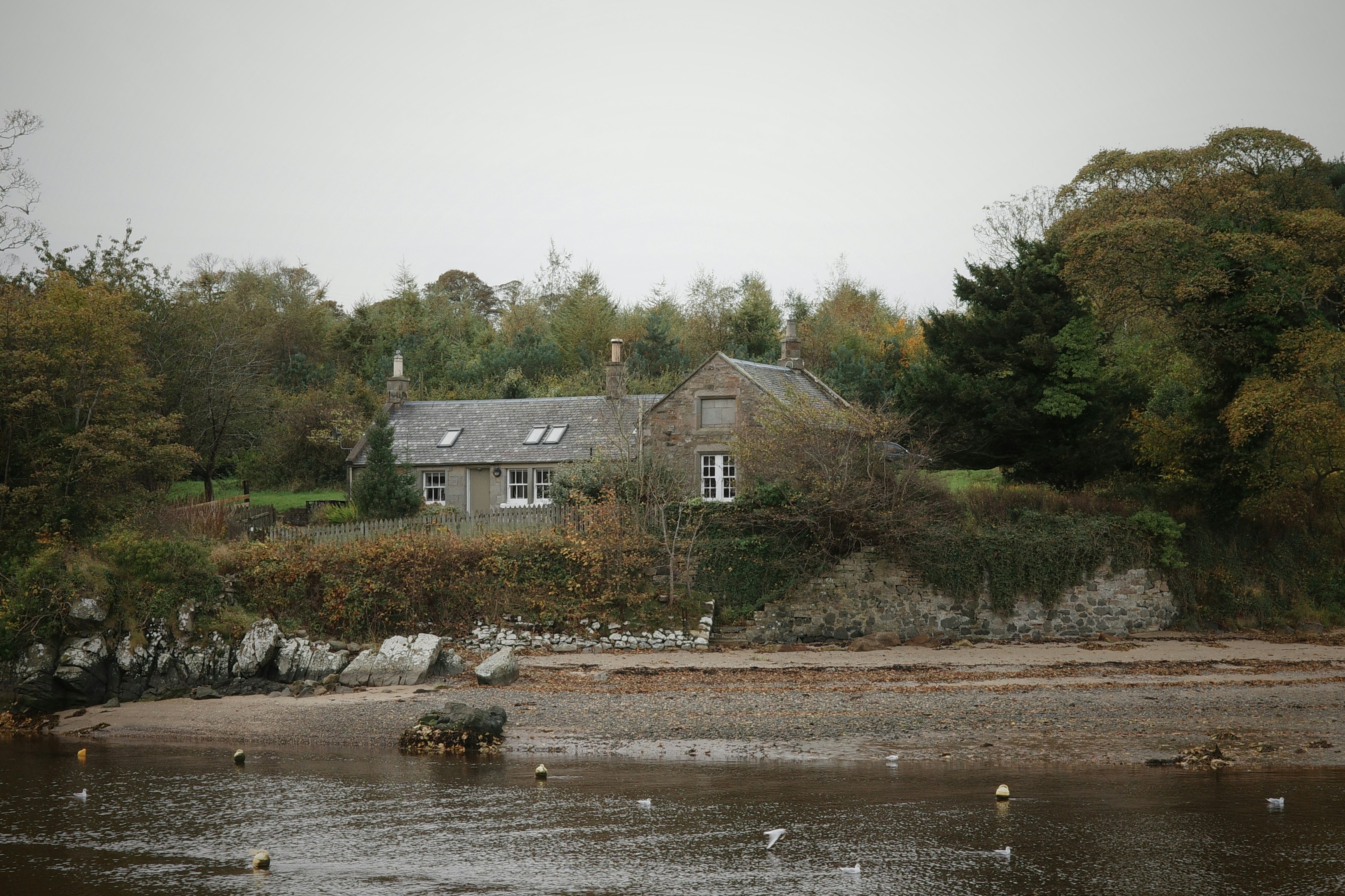 Autumn Riverside Cottage Under Muted Skies