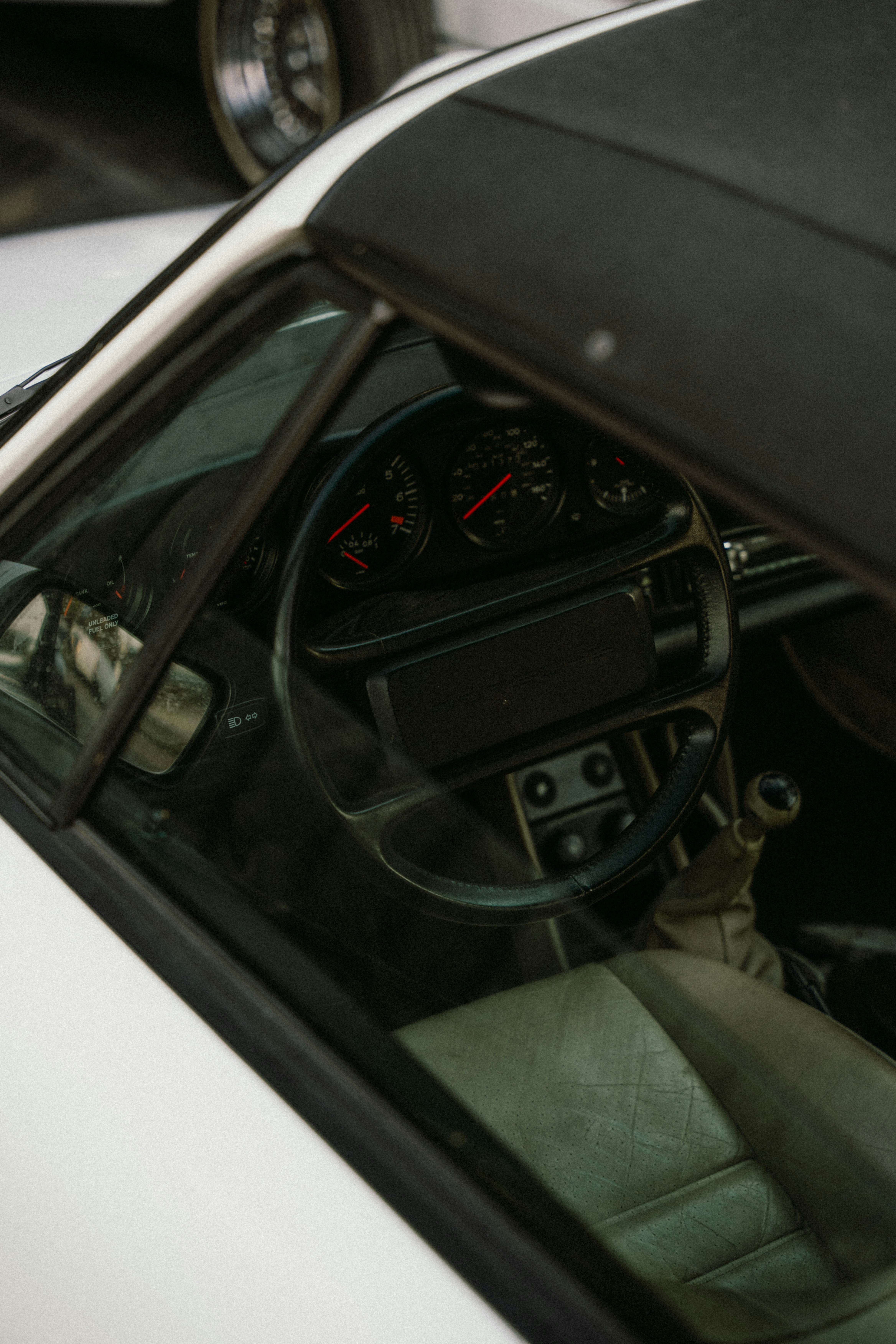 Through the Glass: The Worn Elegance of a Vintage Convertible Dashboard