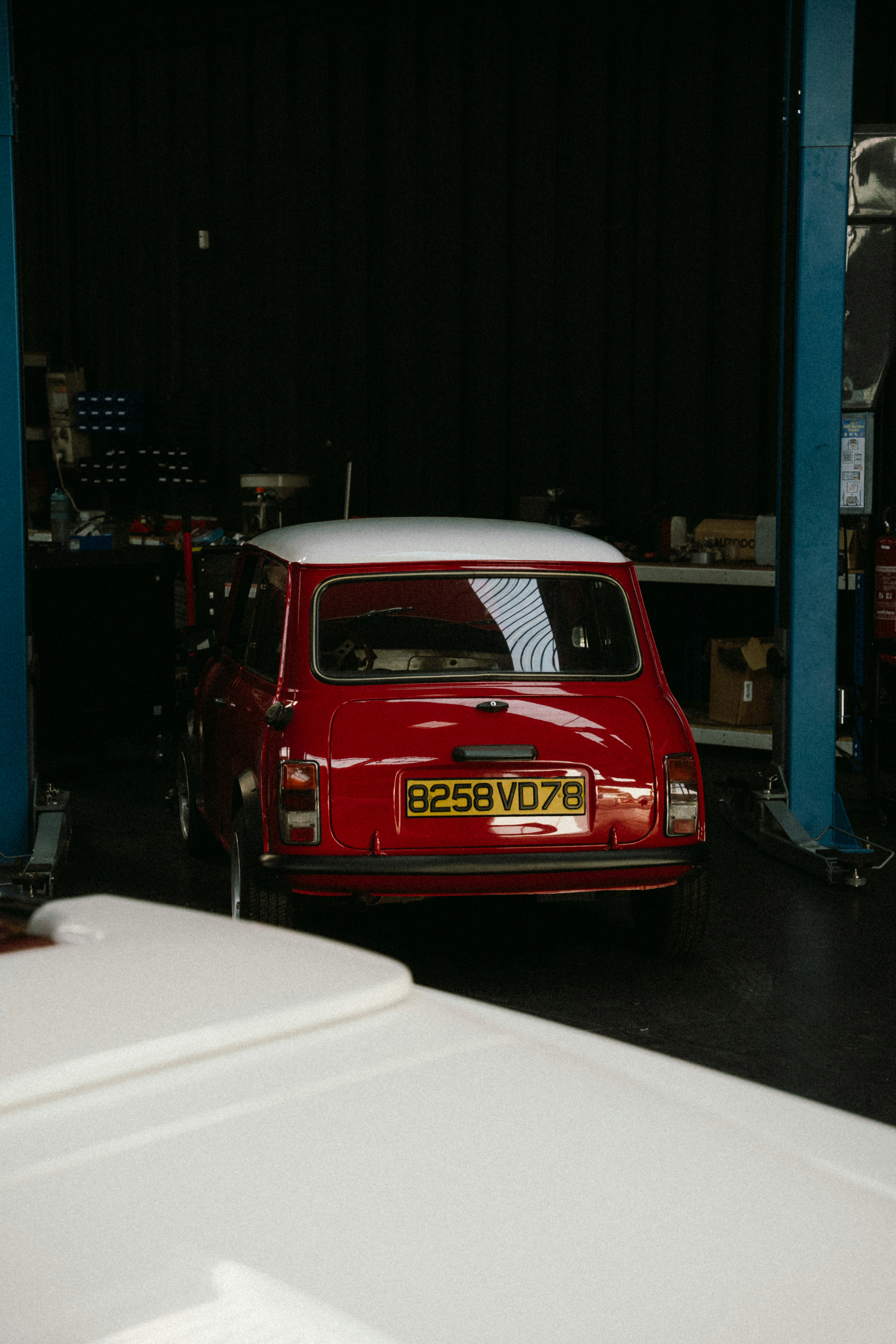 A small red car parked in a garage photo – Free Car Image on Unsplash