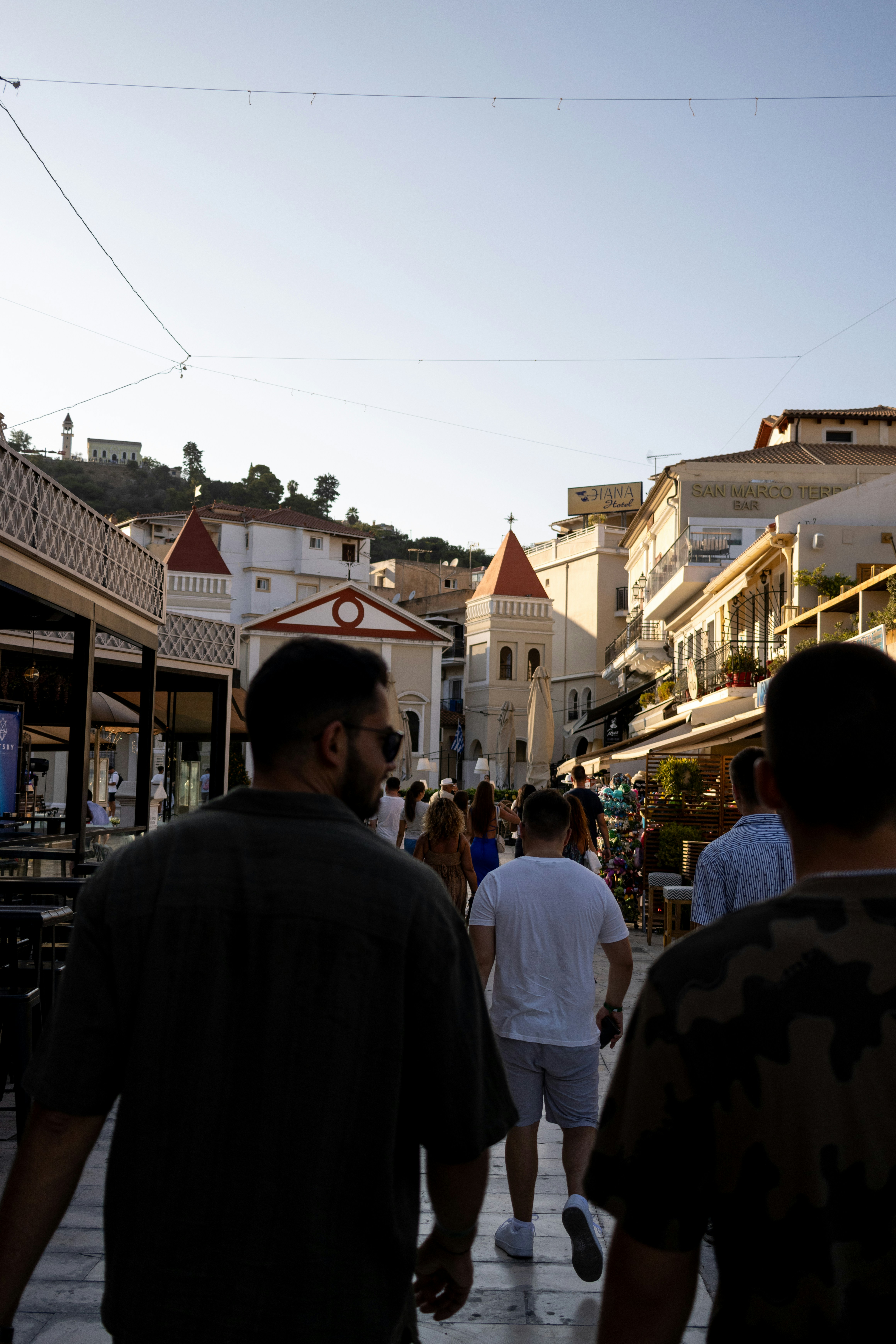 Crowded Mediterranean Thoroughfare Beneath Crescent Towers