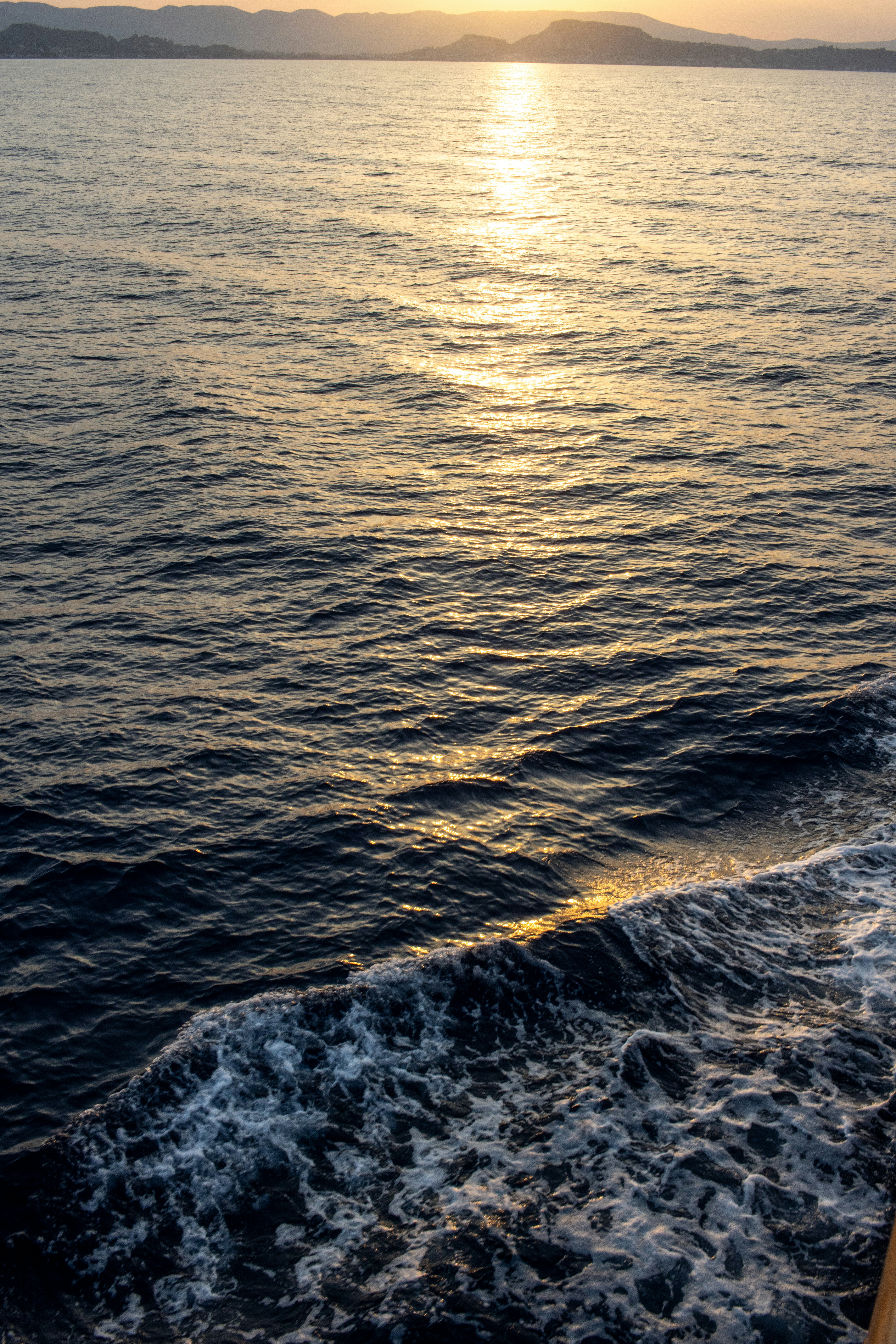 Gilded Horizon: Sunset Reflections on a Quiet Sea