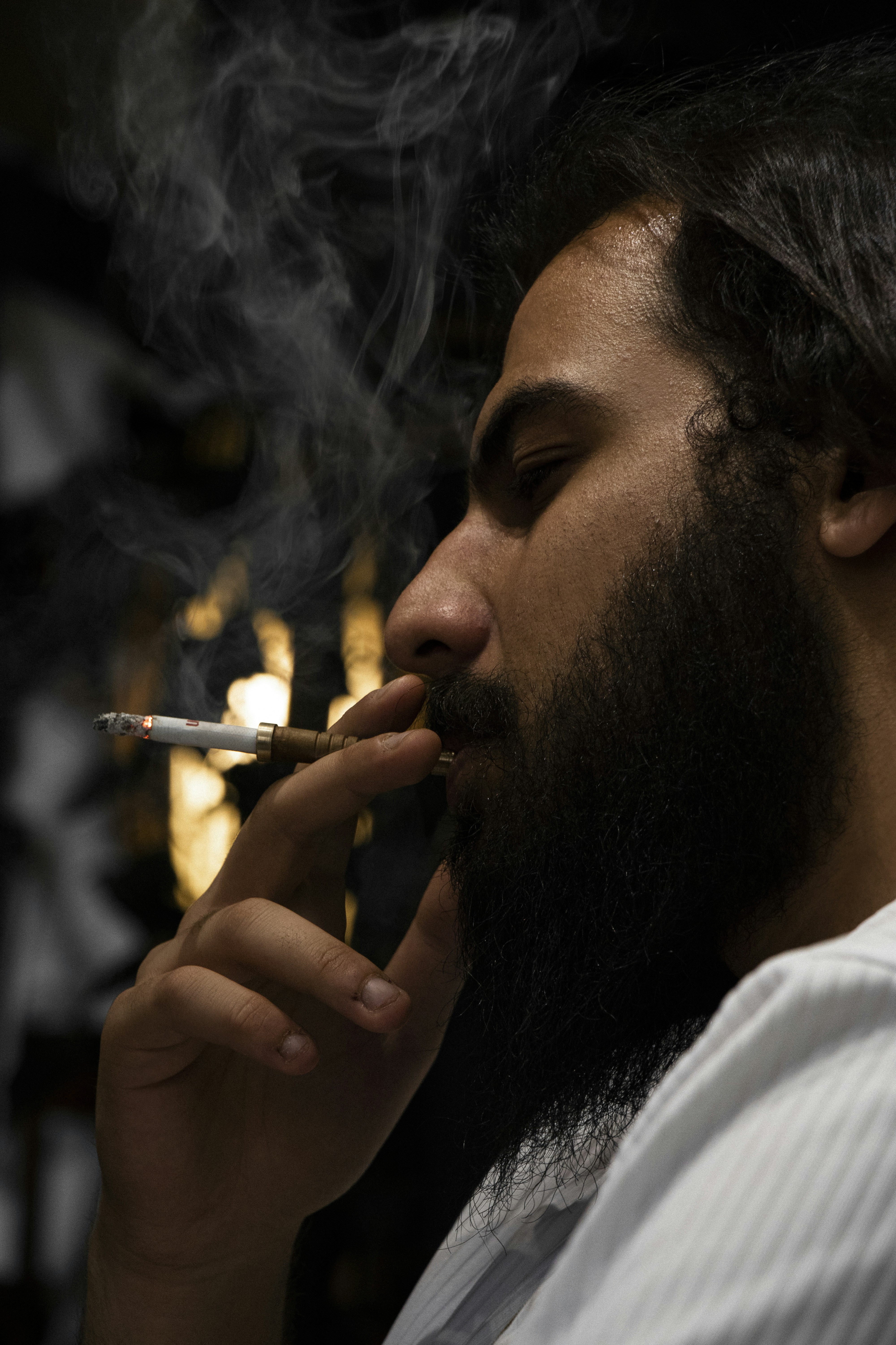 A man with a beard smoking a cigarette photo – Free Tabriz Image on ...