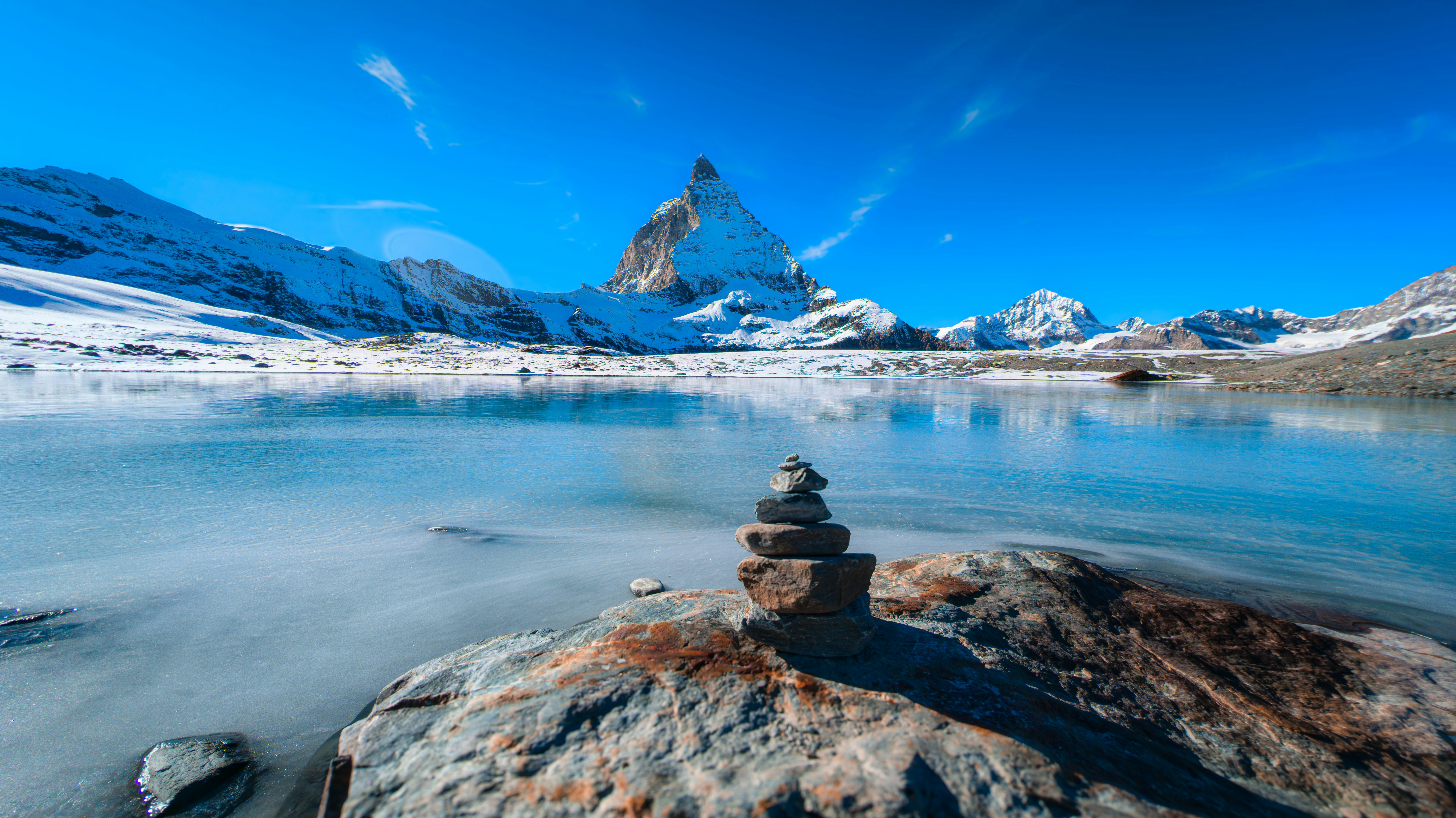 Stone Tower at the Glacier Edge with Alp Peak Backdrop