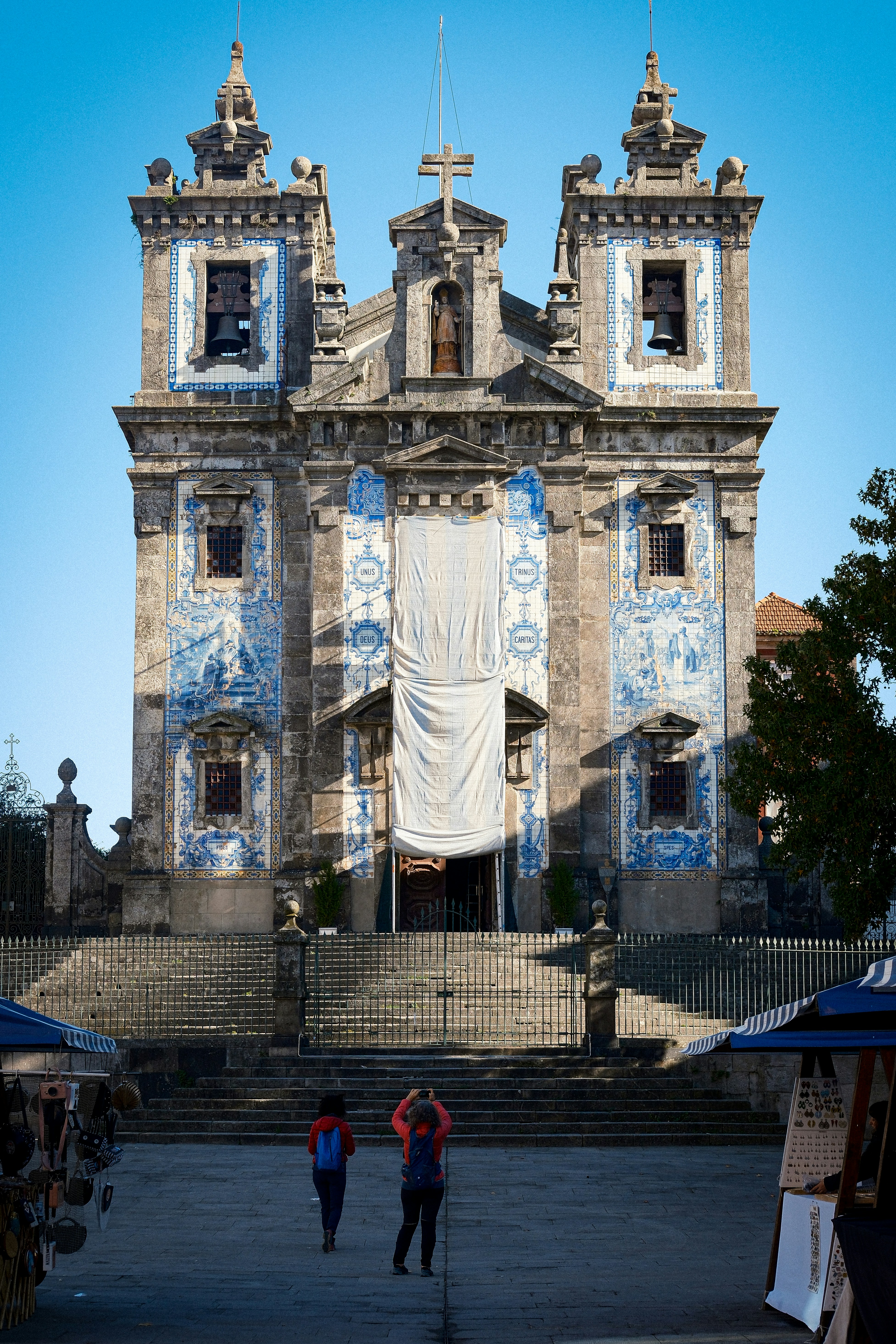 Draped Portal Above Azul Tile Facade: A Baroque Church in the Square