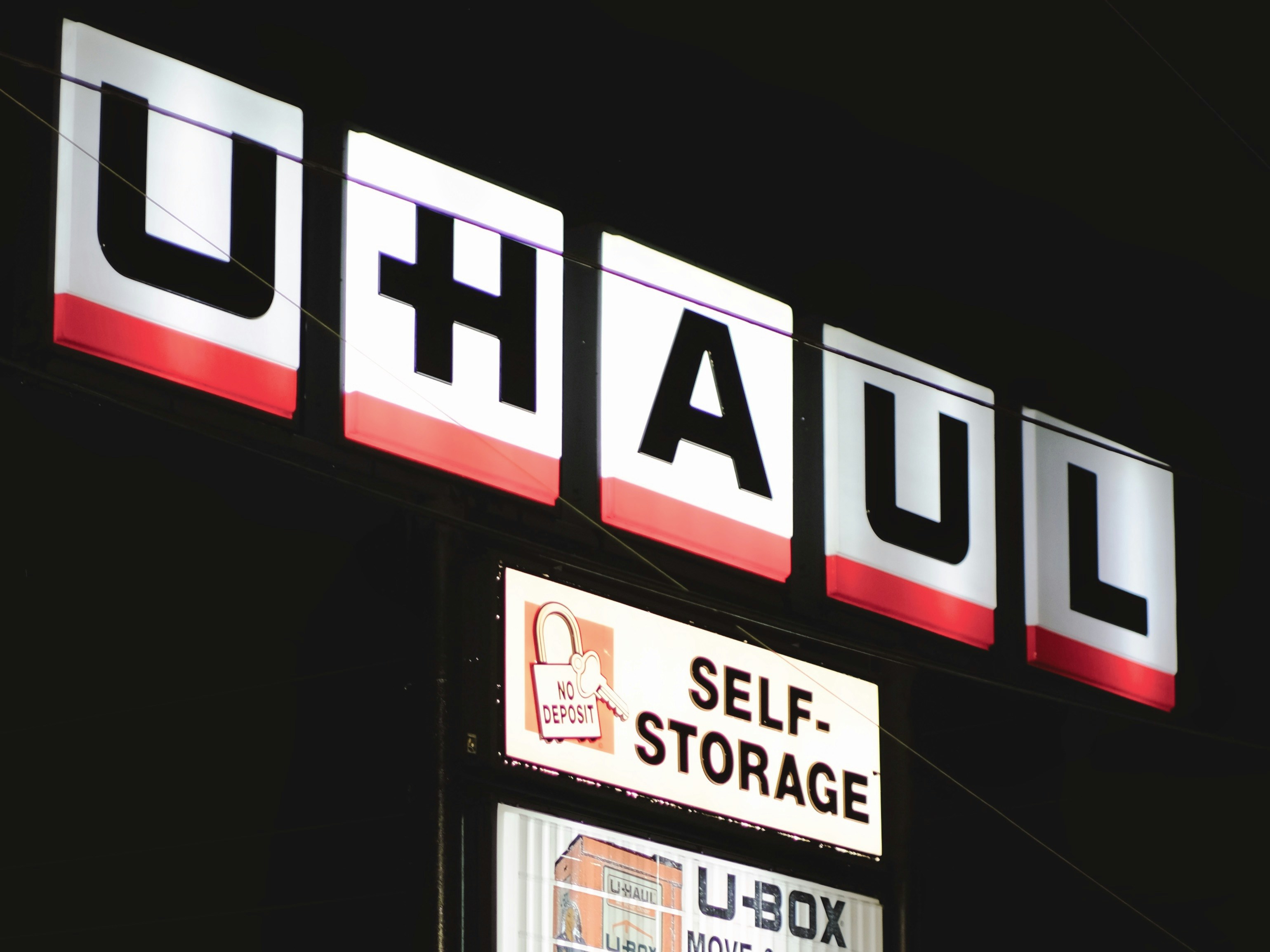 A sign for a self storage store lit up at night photo – Free Film Image ...