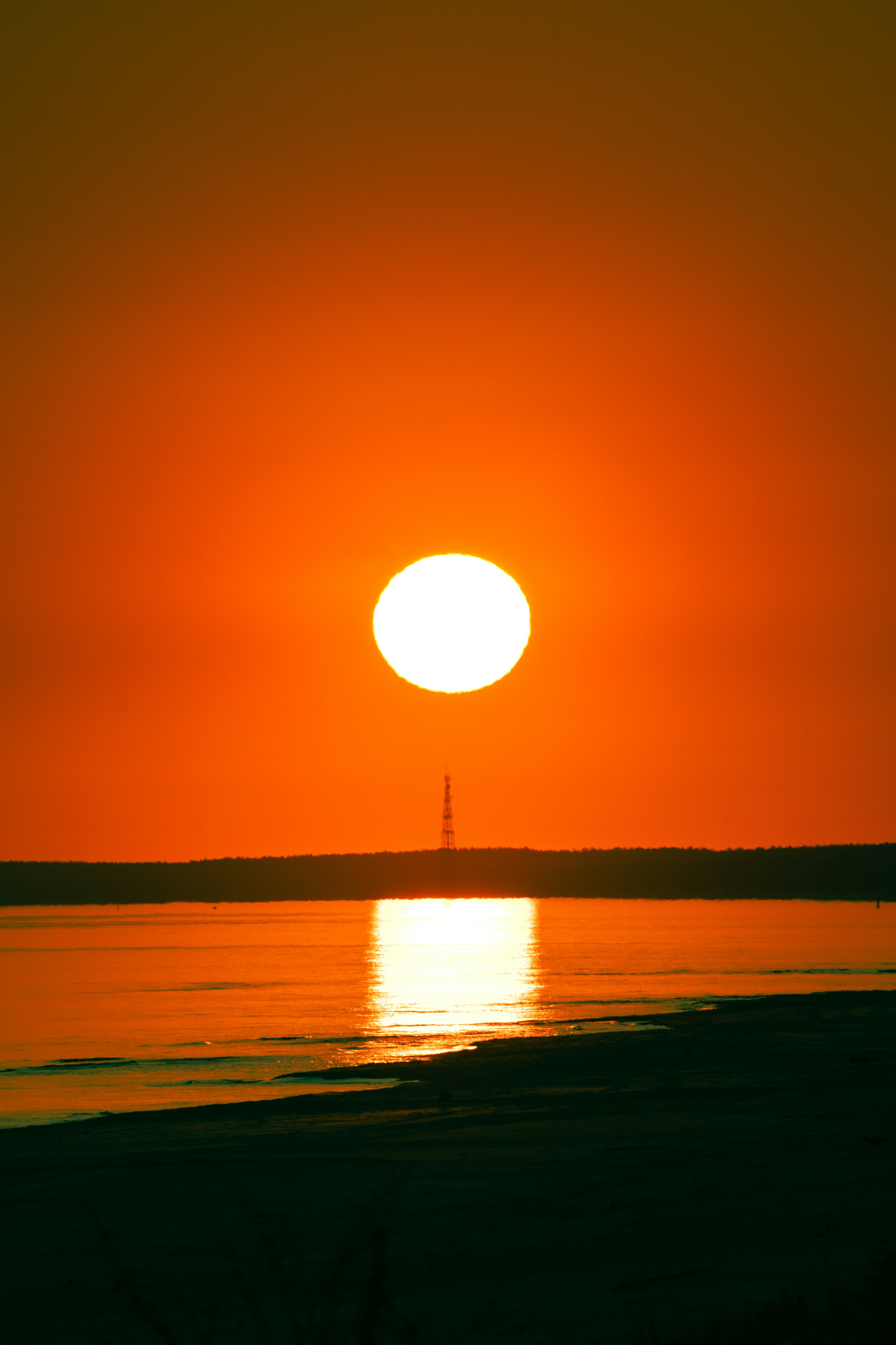 The sun is setting over a body of water photo – Free Krynica morska ...