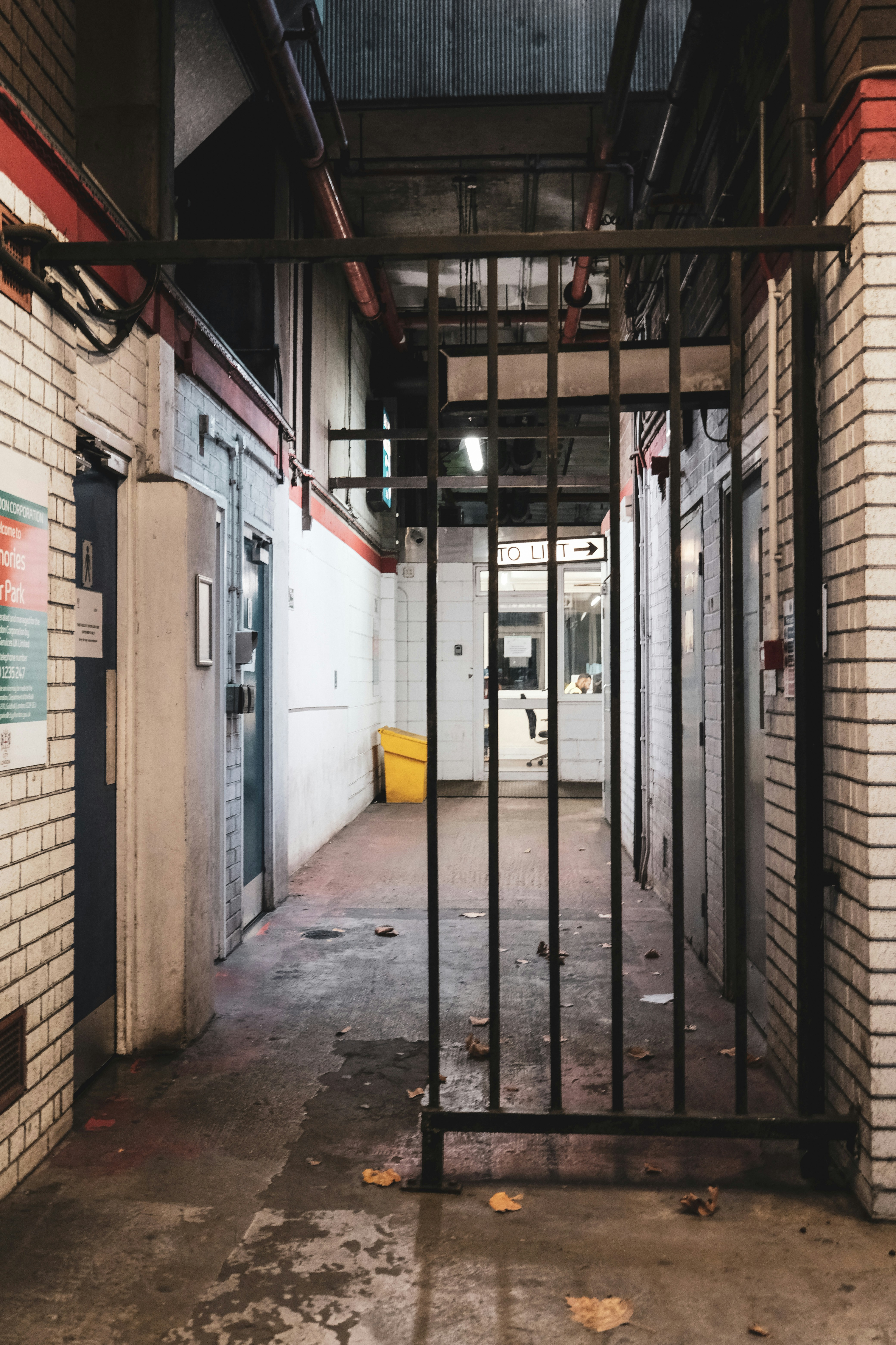 An empty hallway with a bunch of bars on the wall photo – Free Minories ...