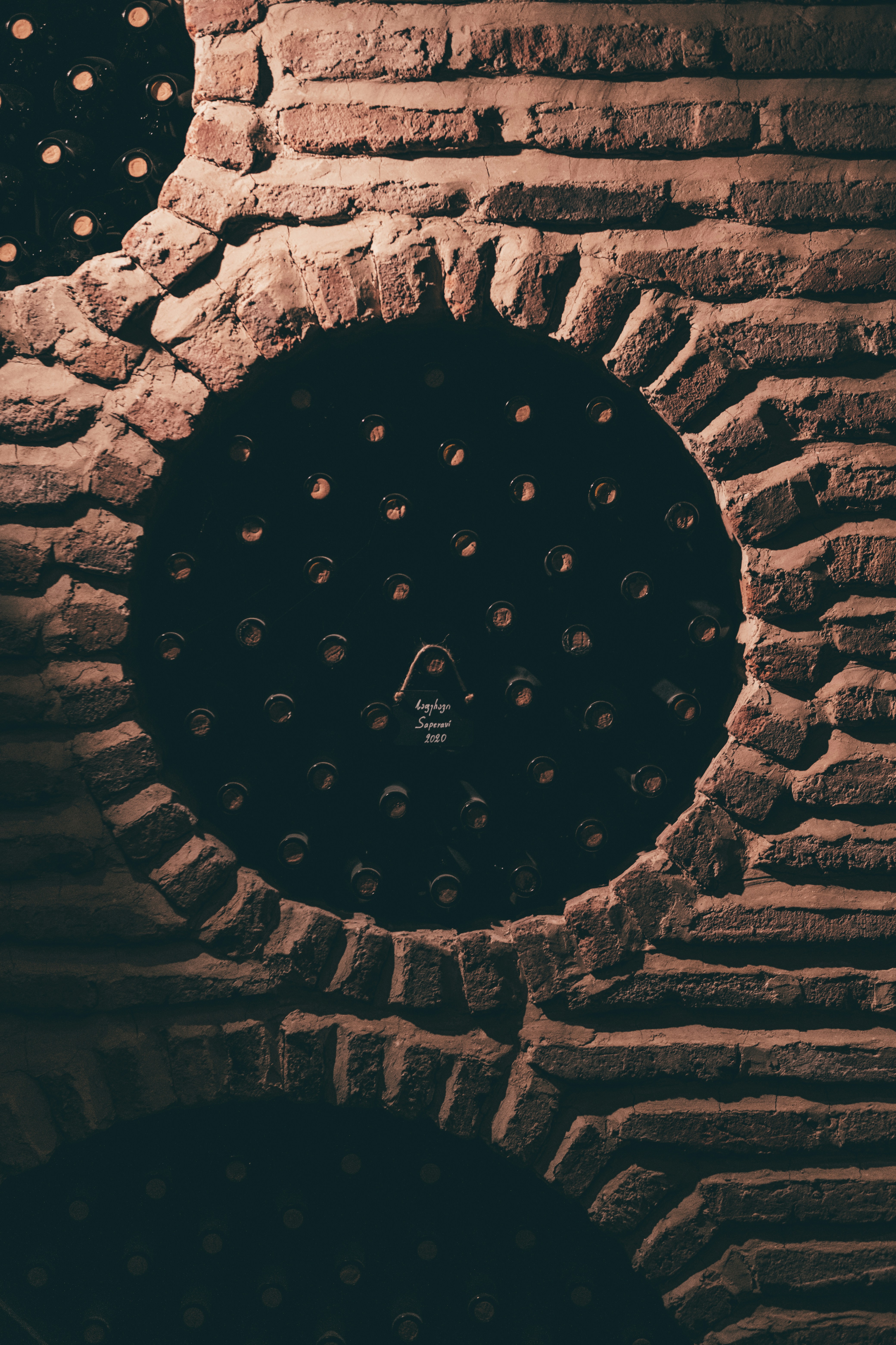 A close up of a brick wall with a clock on it