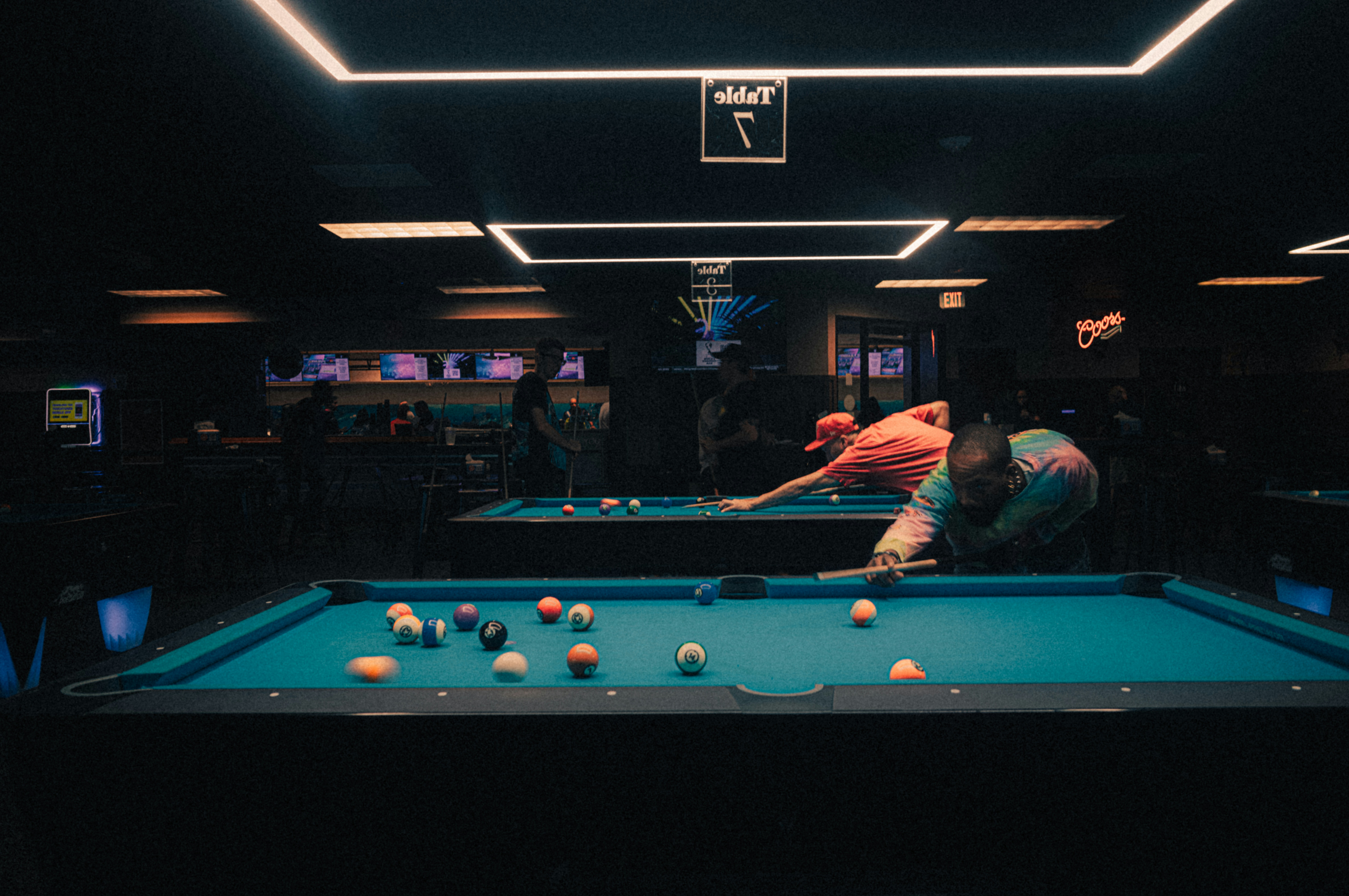 A pool table with a man playing a game of pool photo – Free Adult Image ...
