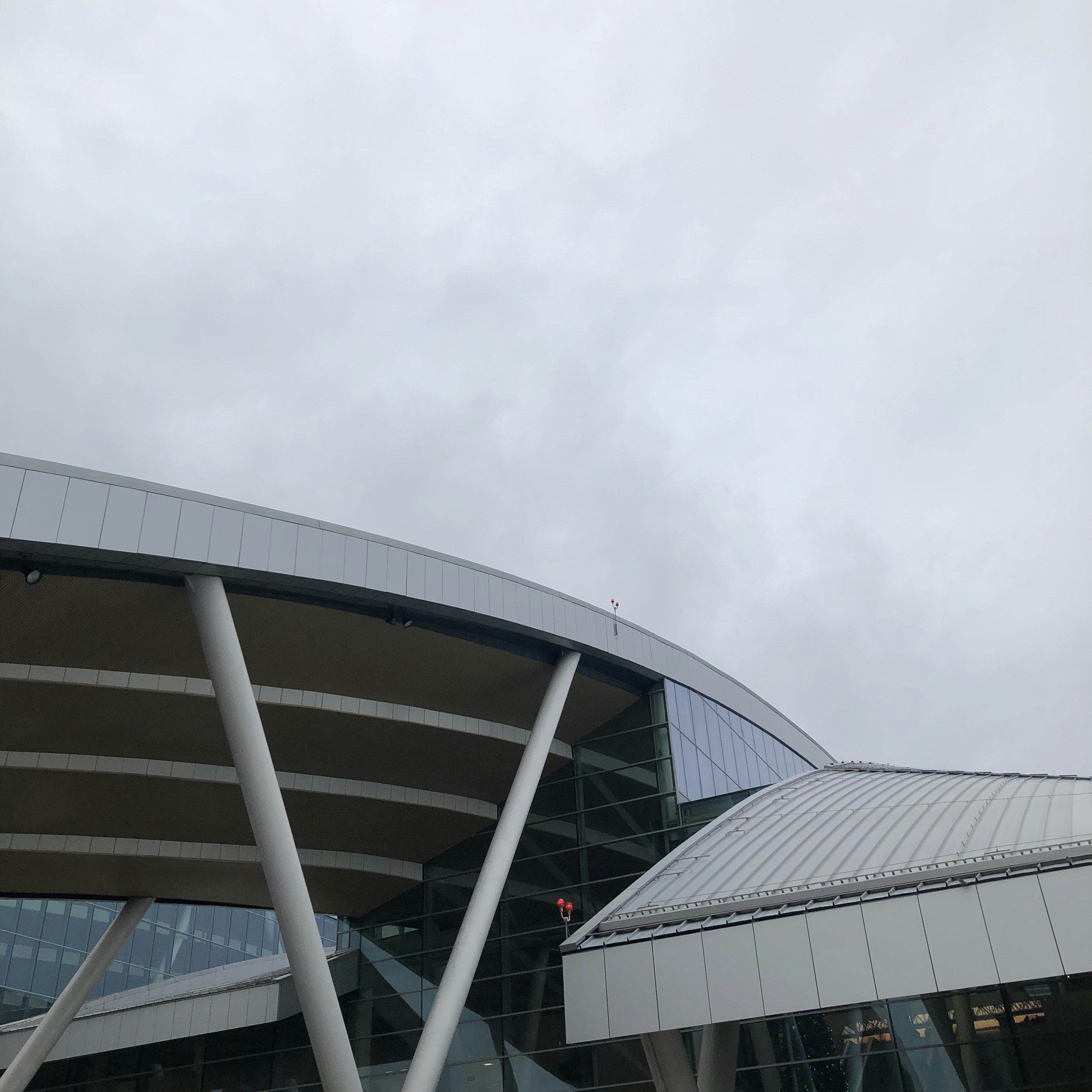 A building with a metal roof and glass walls