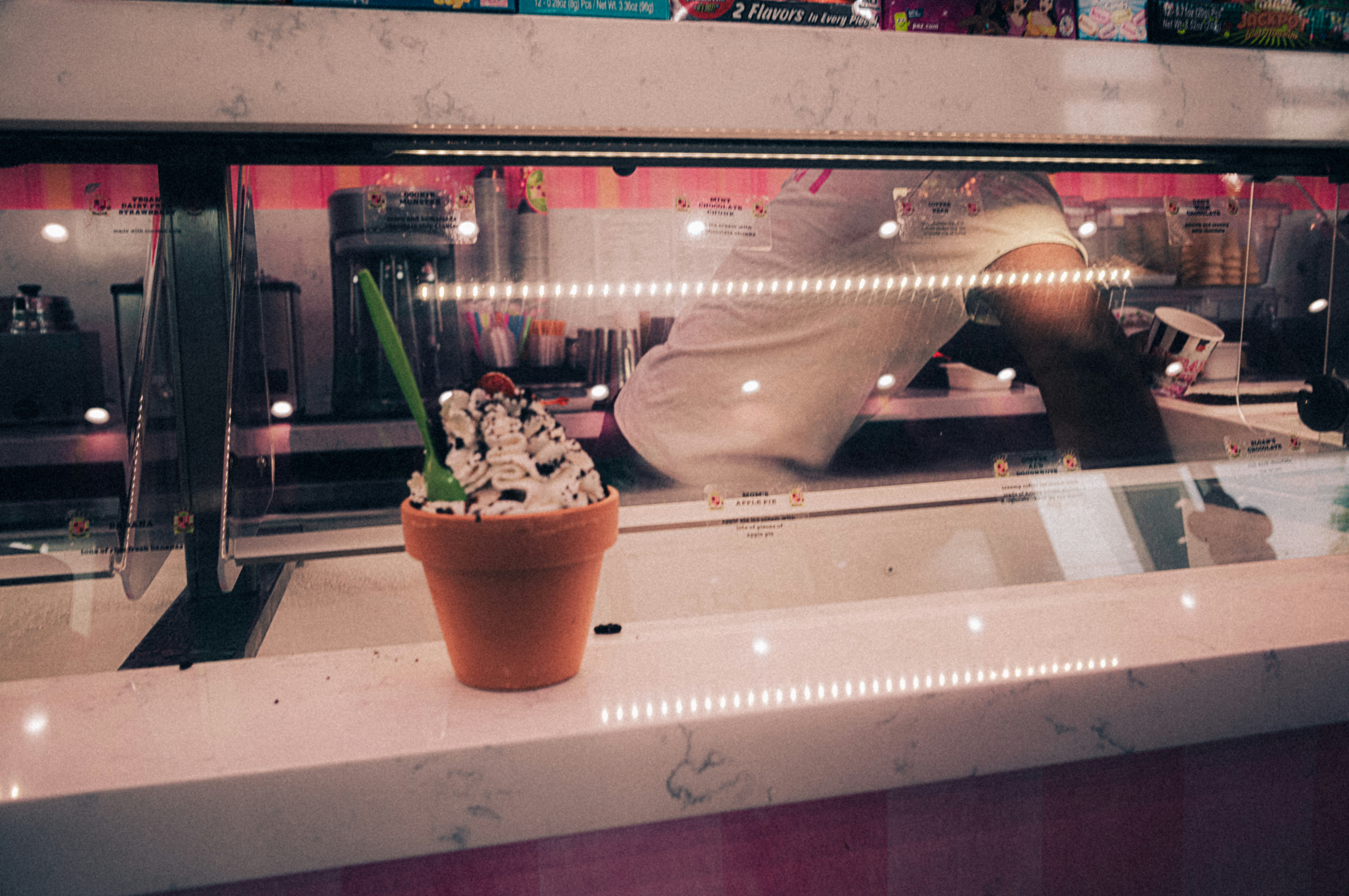 Sundae Under Glass: A Quiet Counter Moment in Neon Reflections
