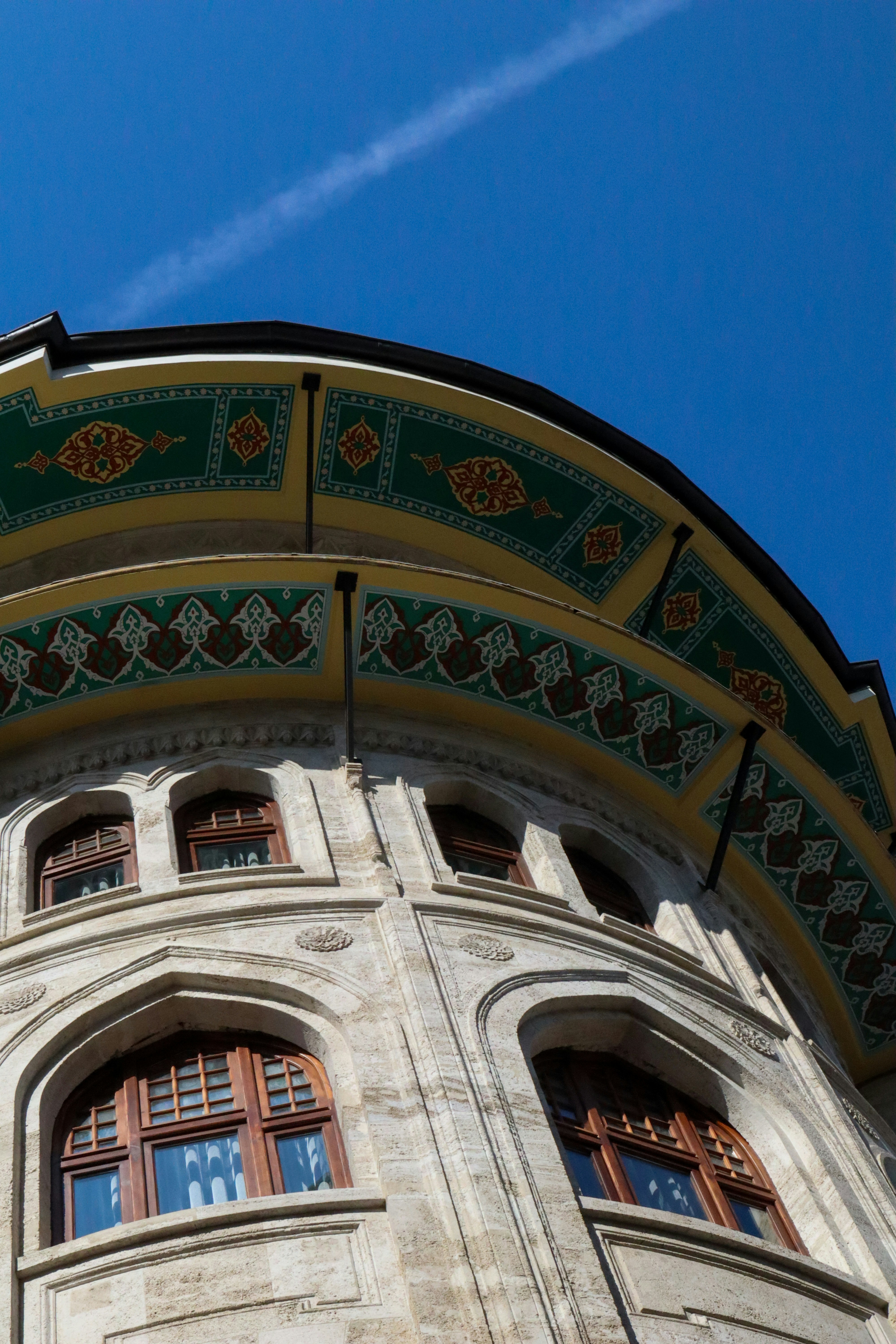 Teal Frieze Archway Against a Pristine Blue Sky
