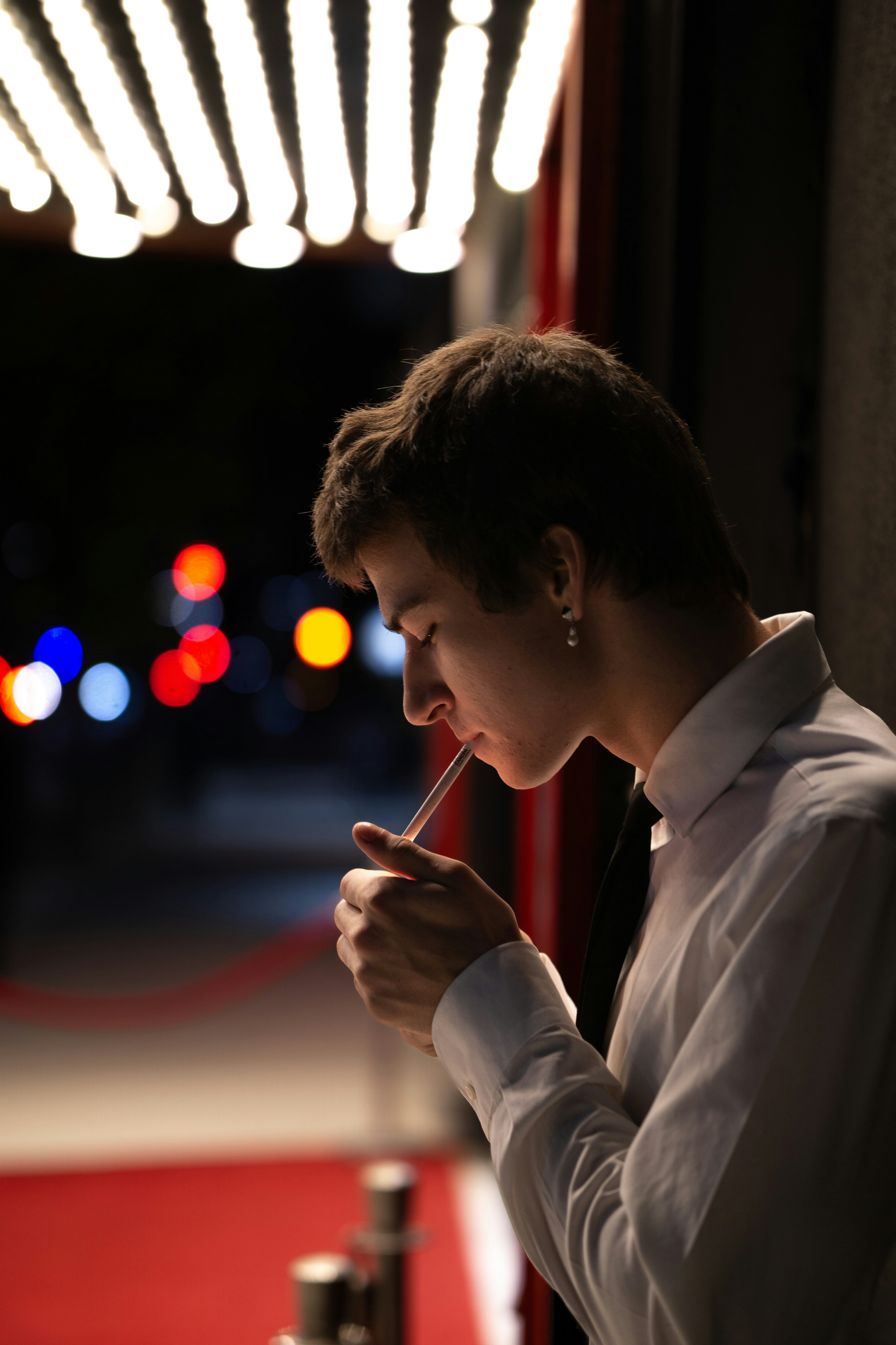Neon Strips and a Quiet Lighter: A Night Portrait in Focus