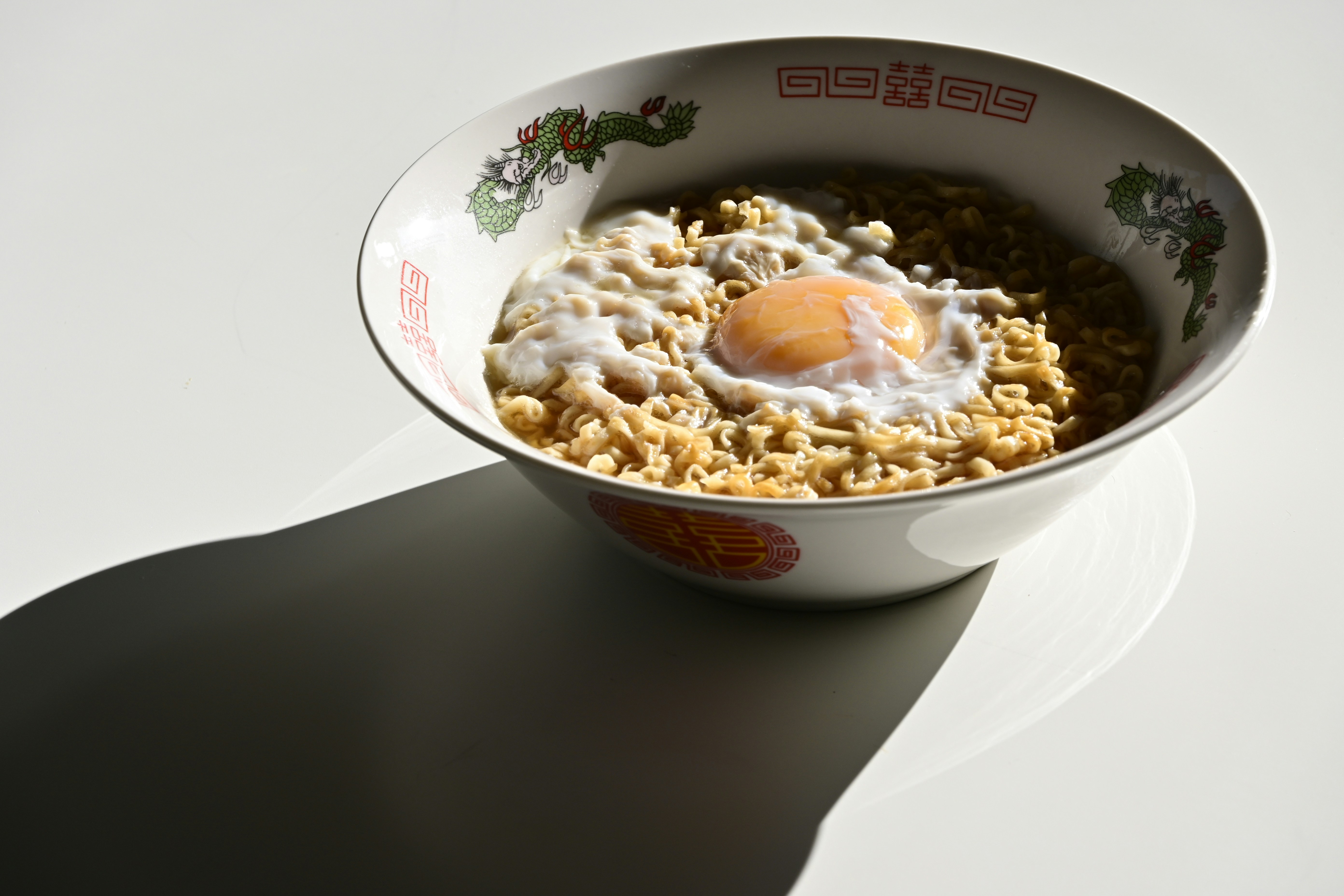 Egg Crown on Dragon Noodles: A Minimalist Shadow Study
