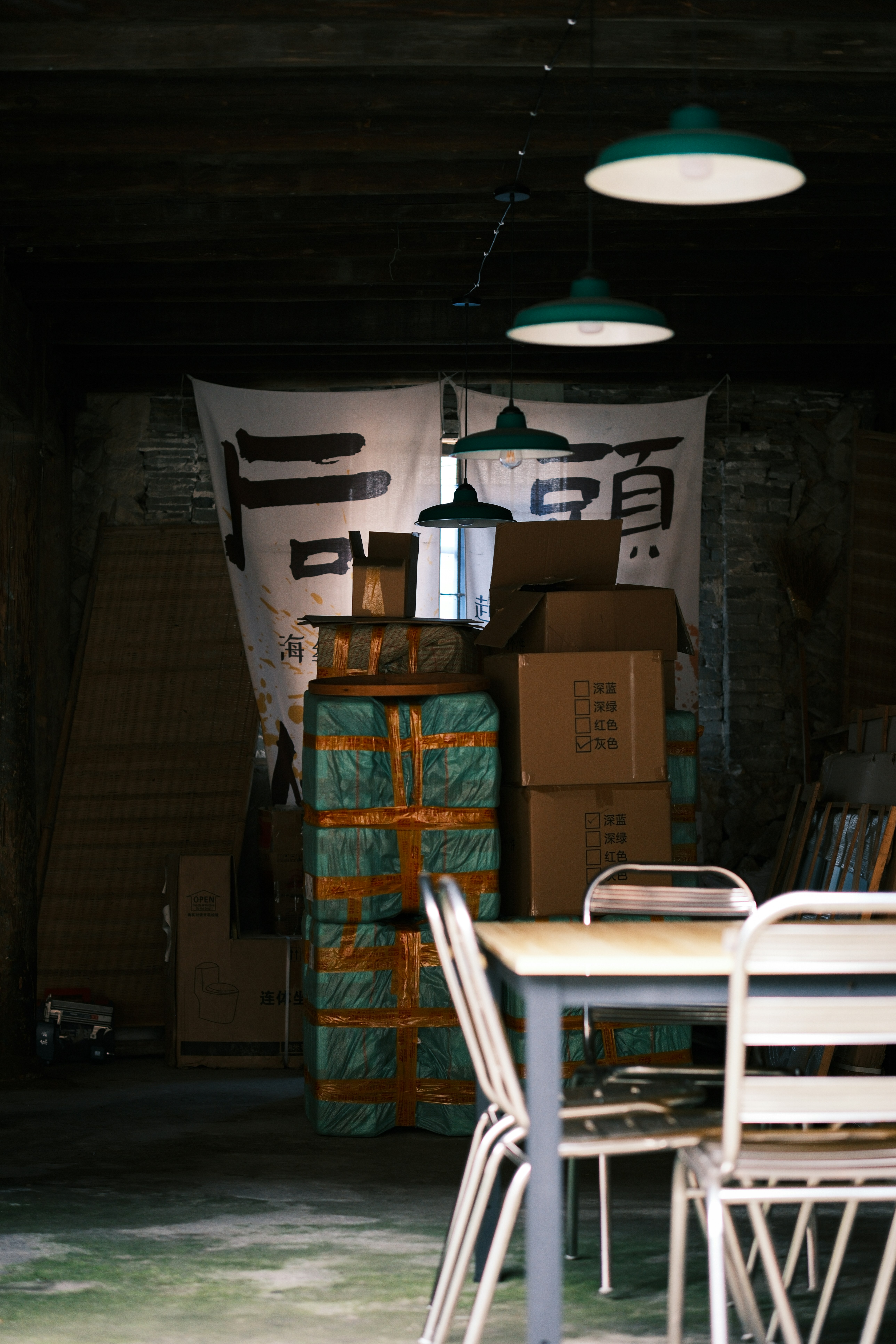 Industrial Quiet: Stacked Boxes Under Dimming Overhead Lights