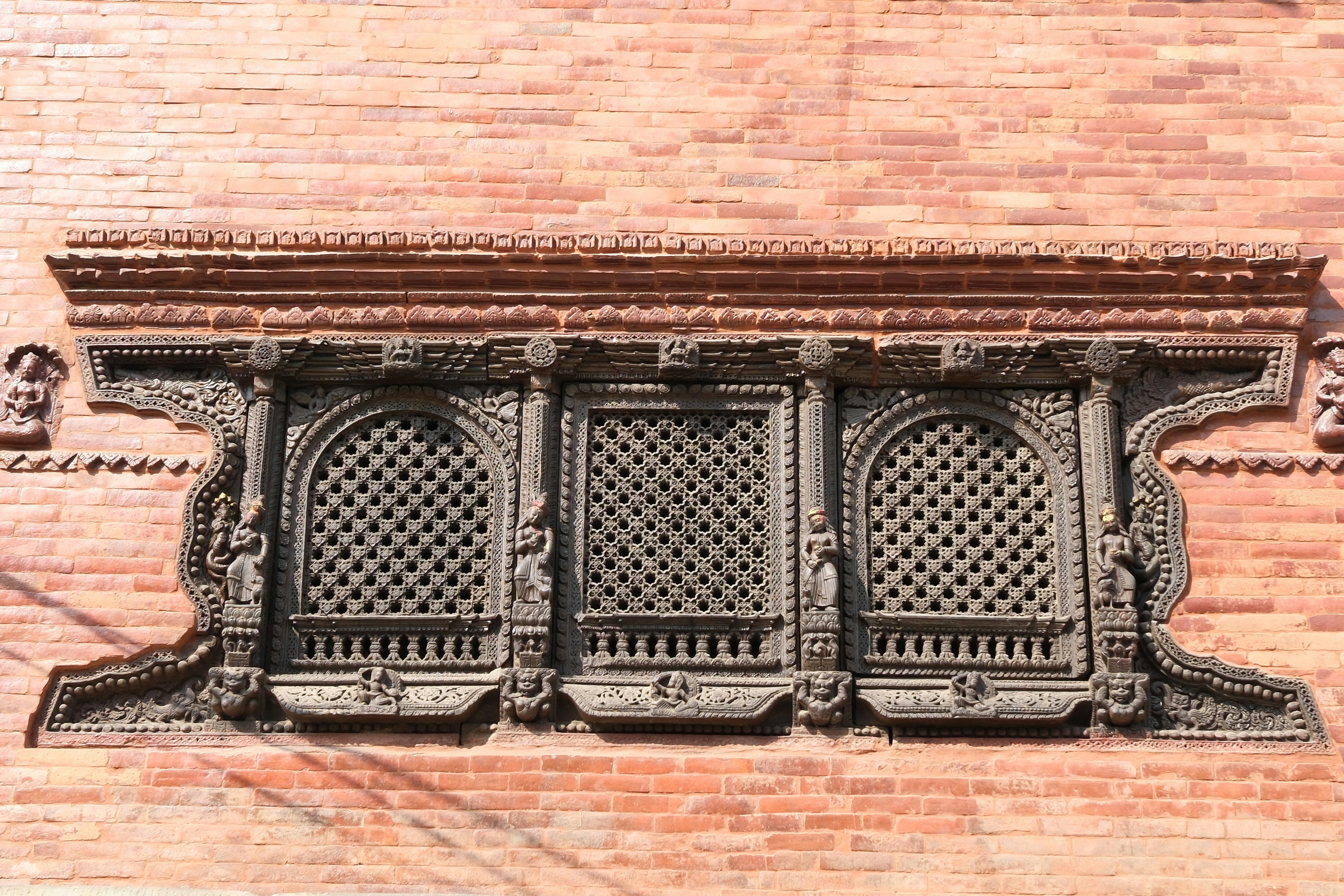 Ornate Brick Facade Window Framing with Intricate Carved Details