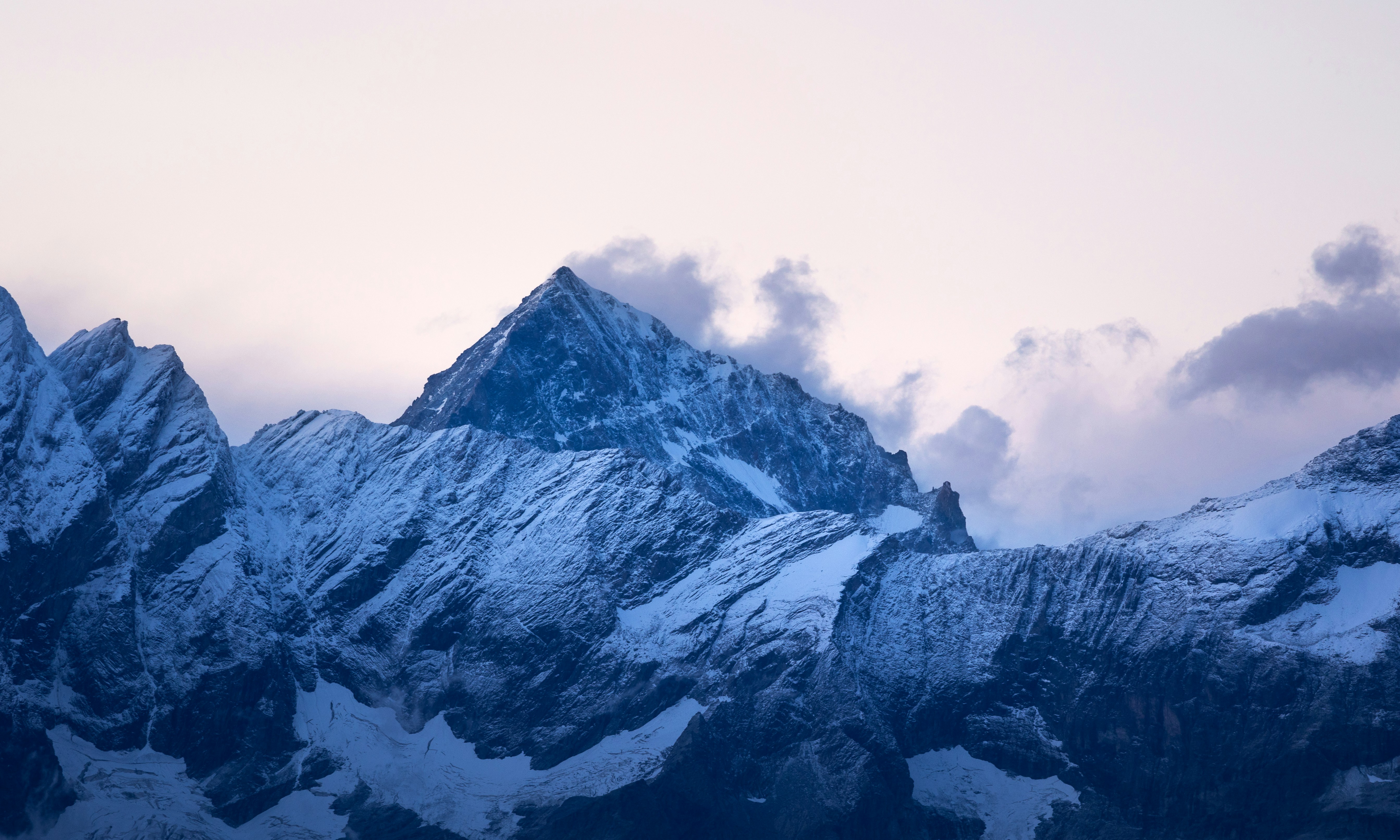 A view of a snowy mountain range at dusk photo – Free Italy Image on ...