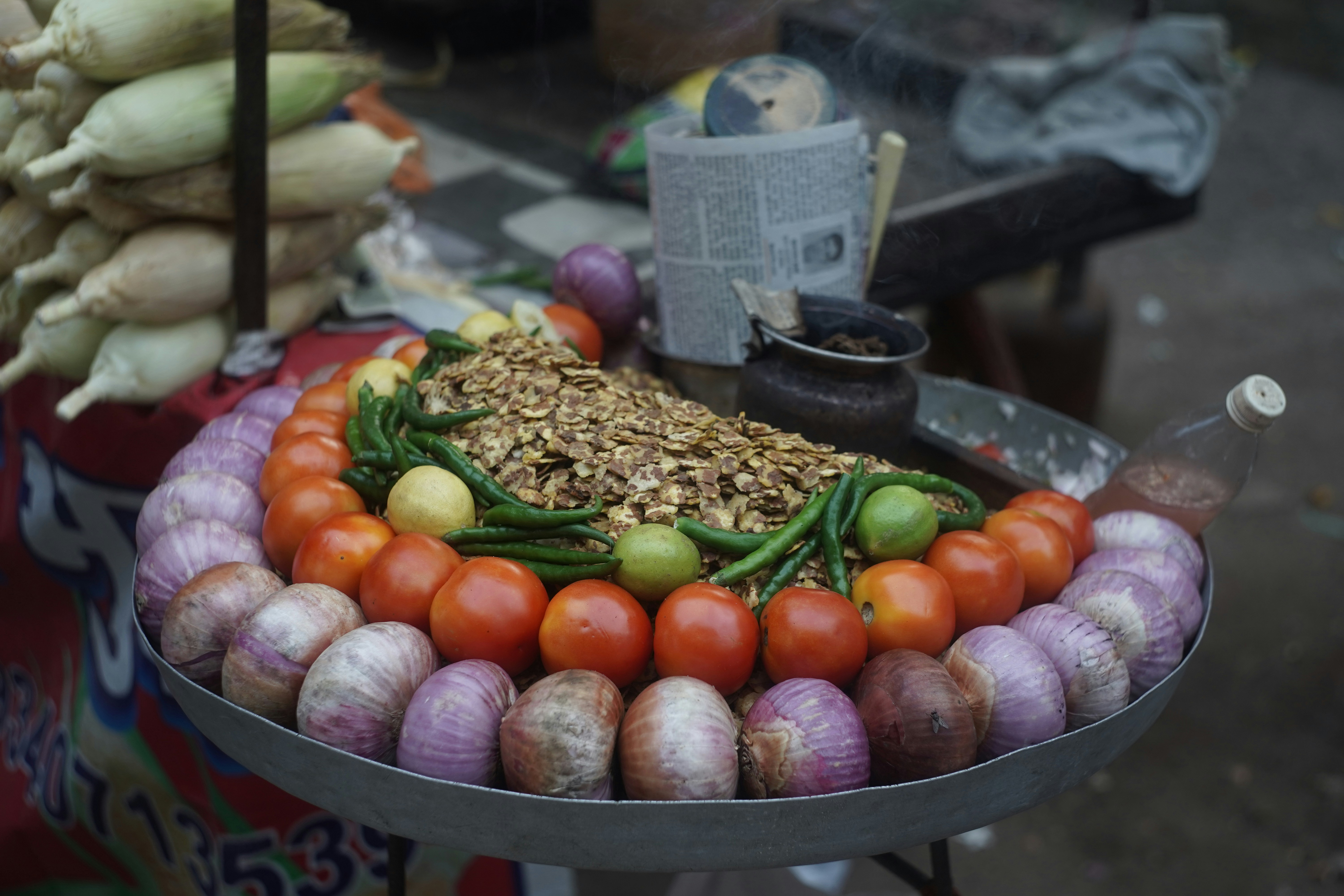 Seed Crown on a Circular Market Tray Amid Onions and Tomatoes