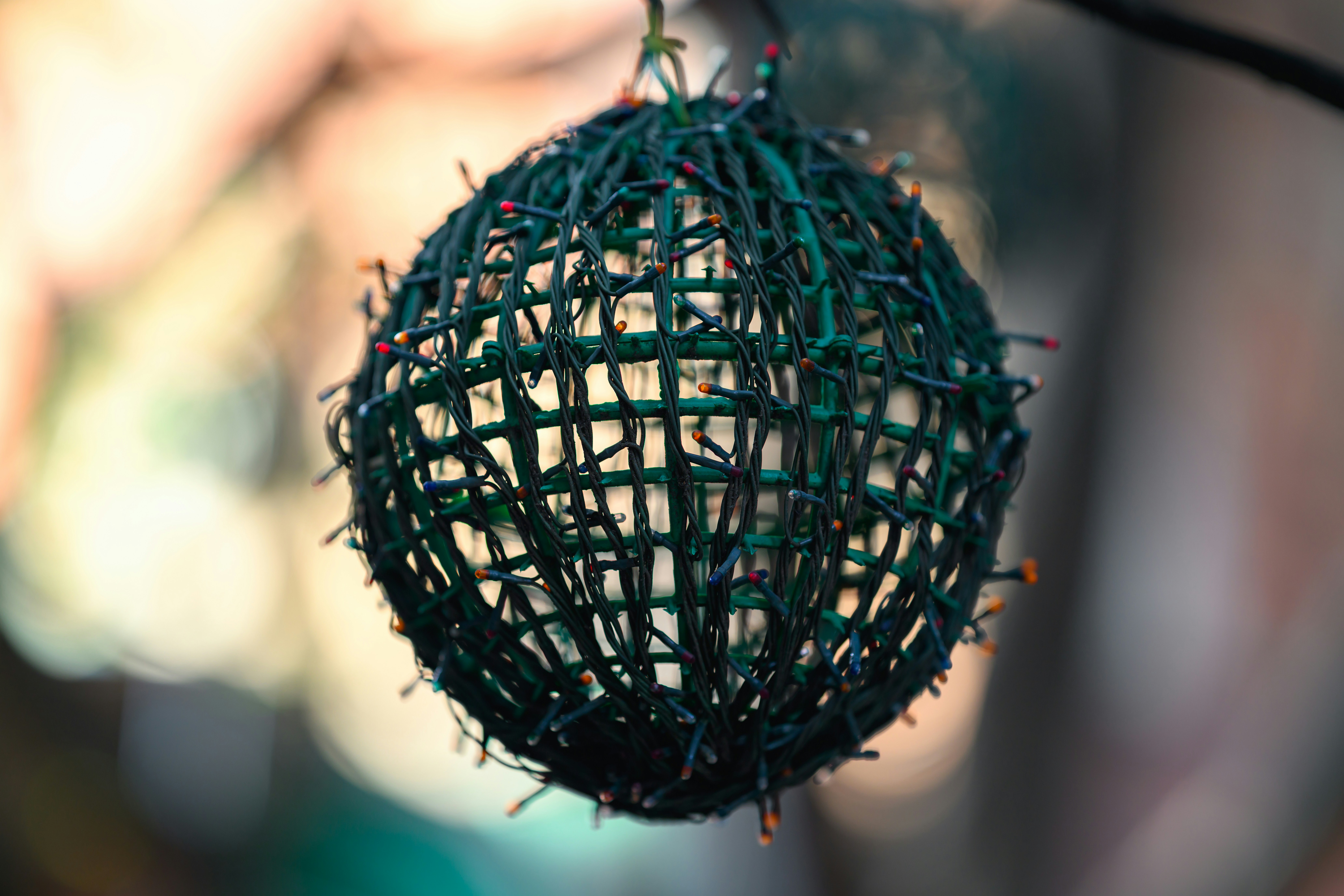Emerald lattice orb suspended in soft bokeh