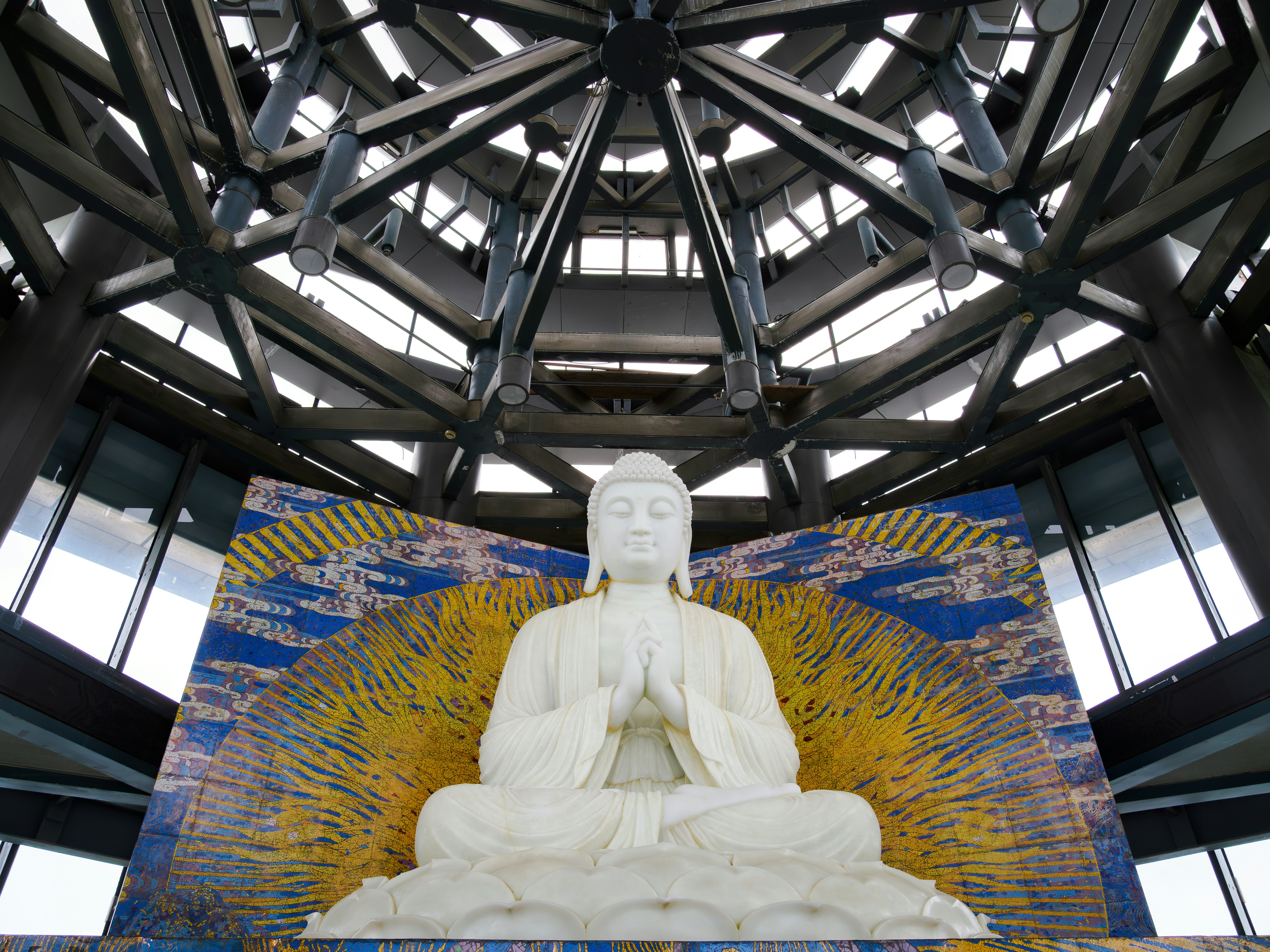 Sunburst Halo Behind a Meditating Buddha in a Glass Cathedral