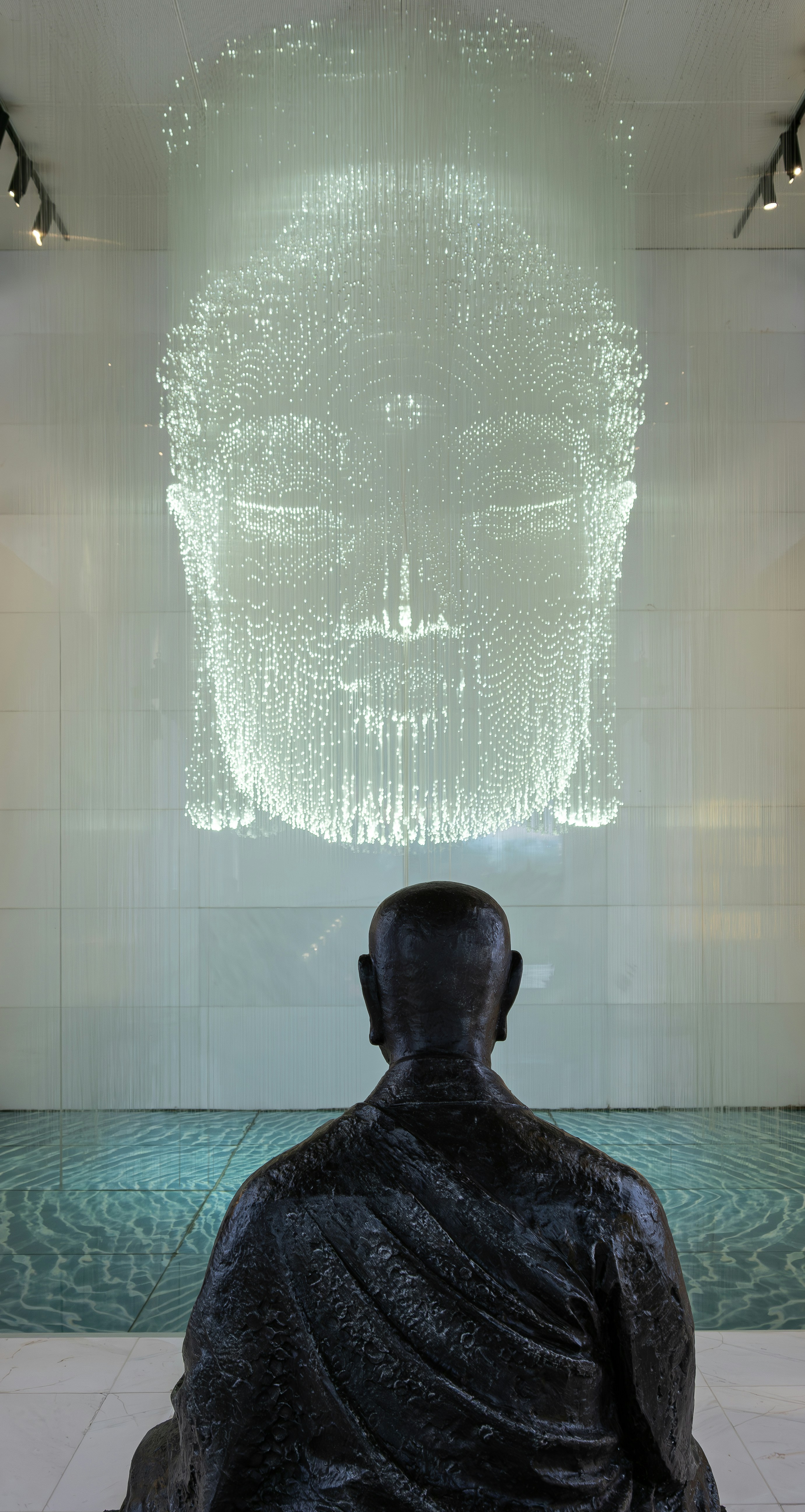 Beaded Beacon: A Seated Figure Faces a Luminous Dot-Portrait