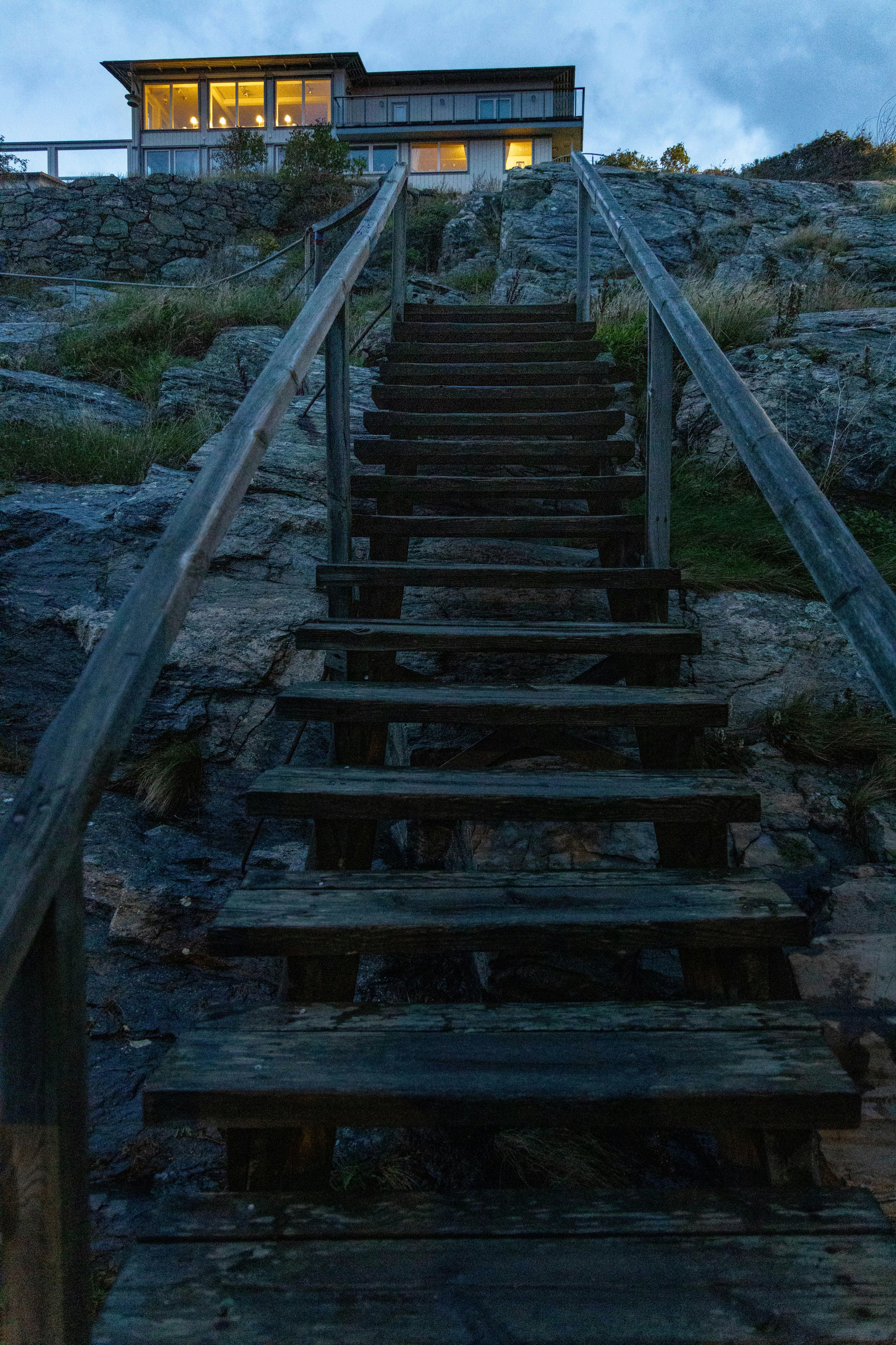 Blue Hour Ascent: Staircase Toward a Glowing Cliffside Retreat