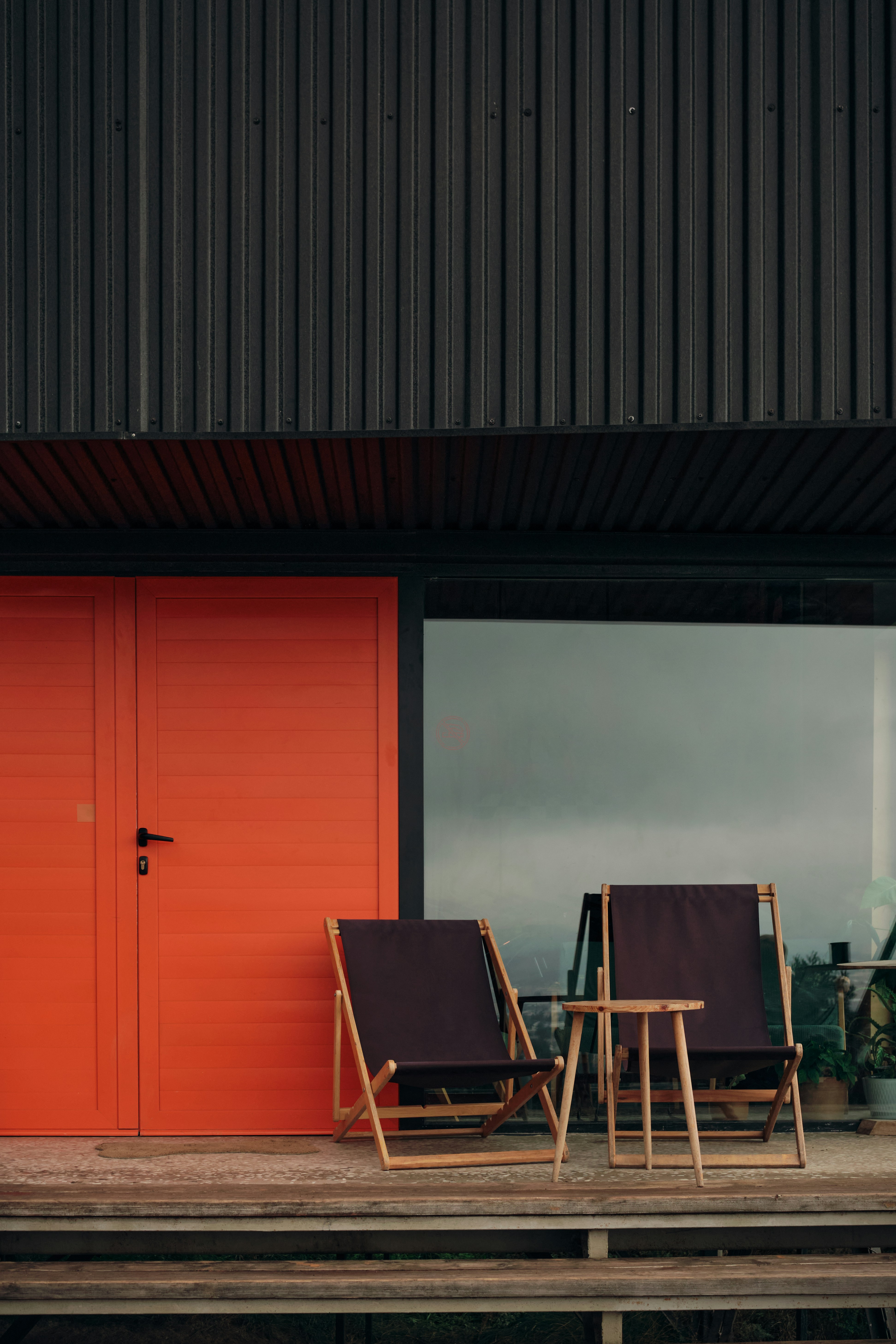 The Orange Threshold: Minimal Porch Scene with Two Deck Chairs