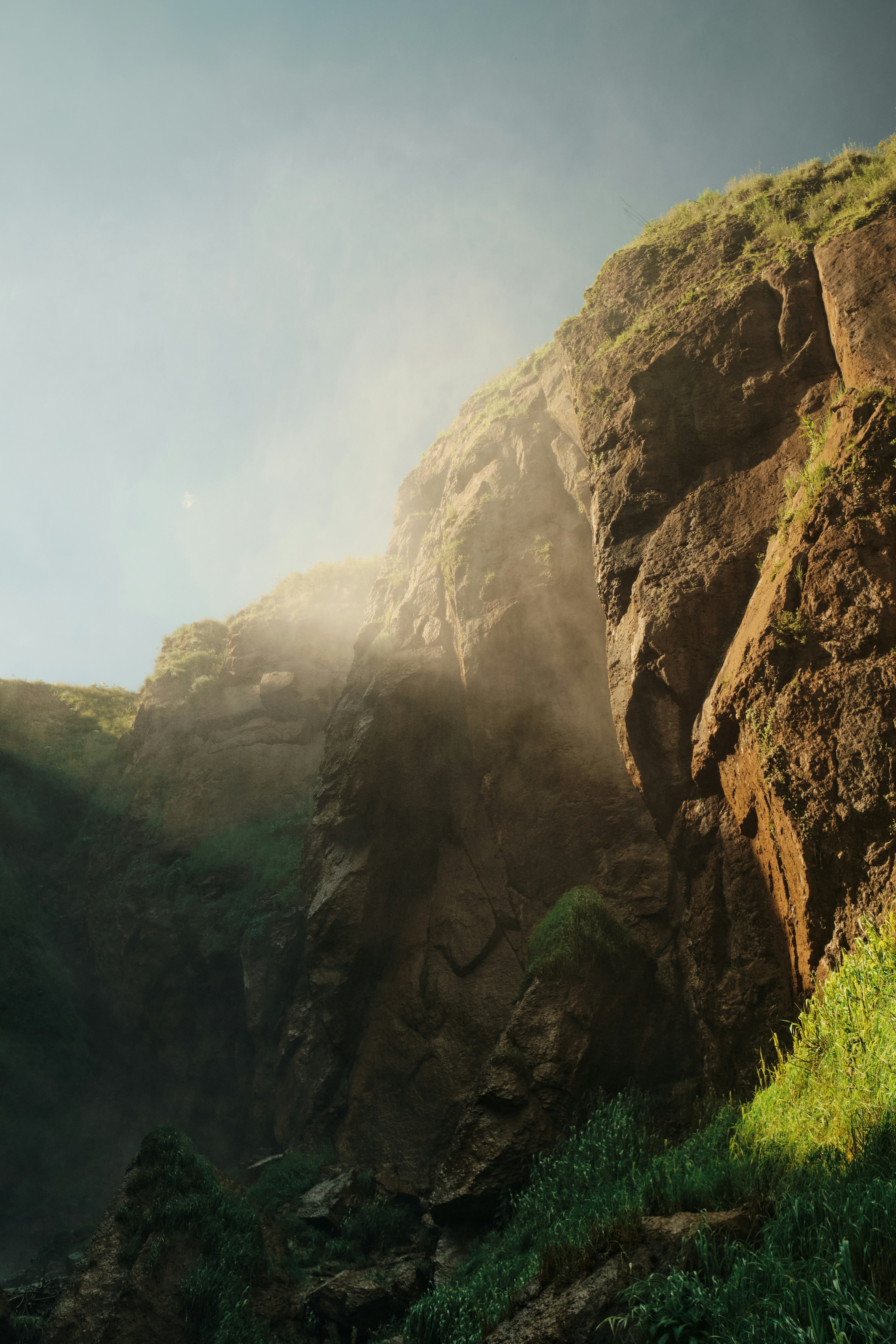 Edge of Light: A Cliff Carved by Mist and Morning Glow