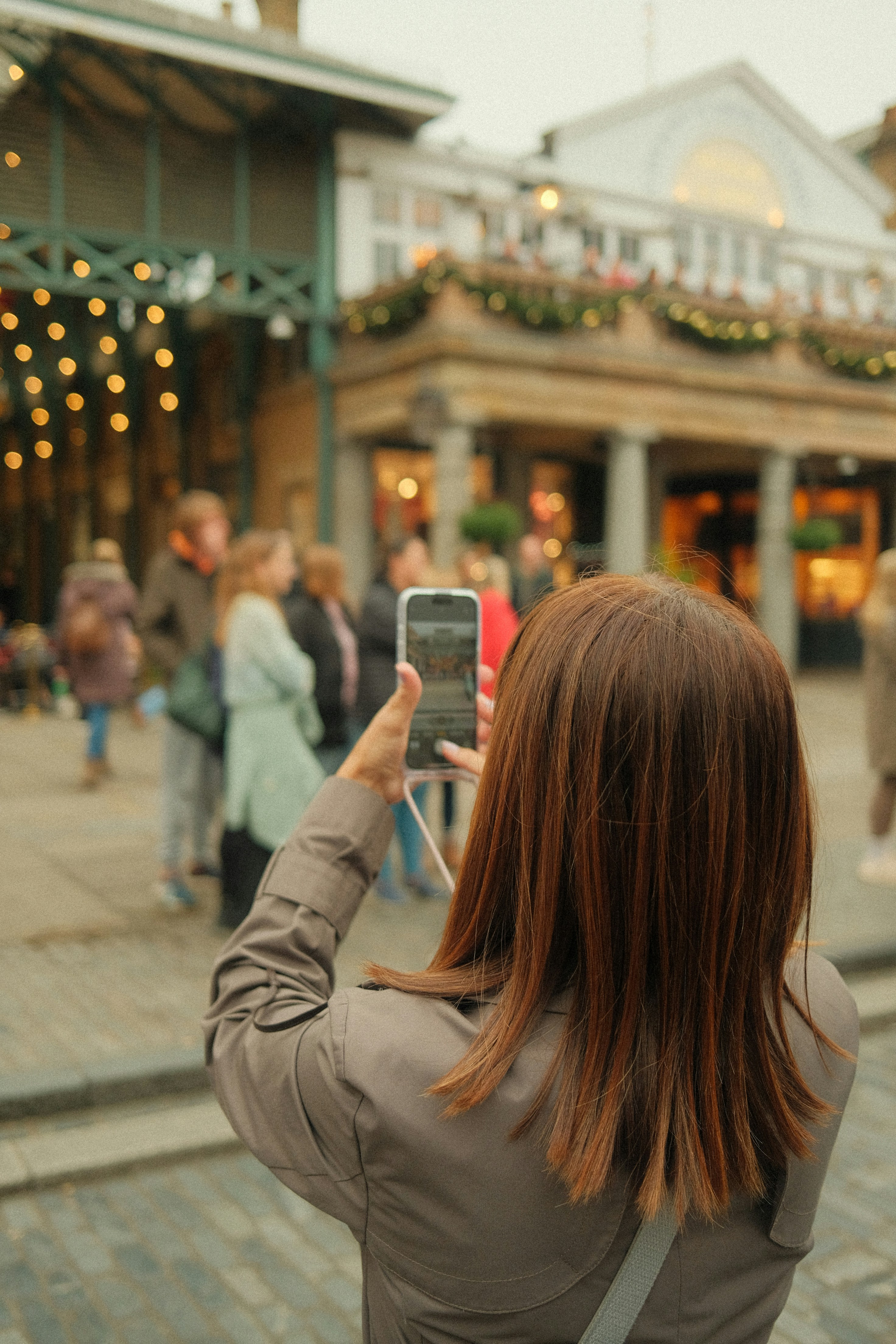 A woman taking a picture of a crowd of people photo – Free Photo Image ...