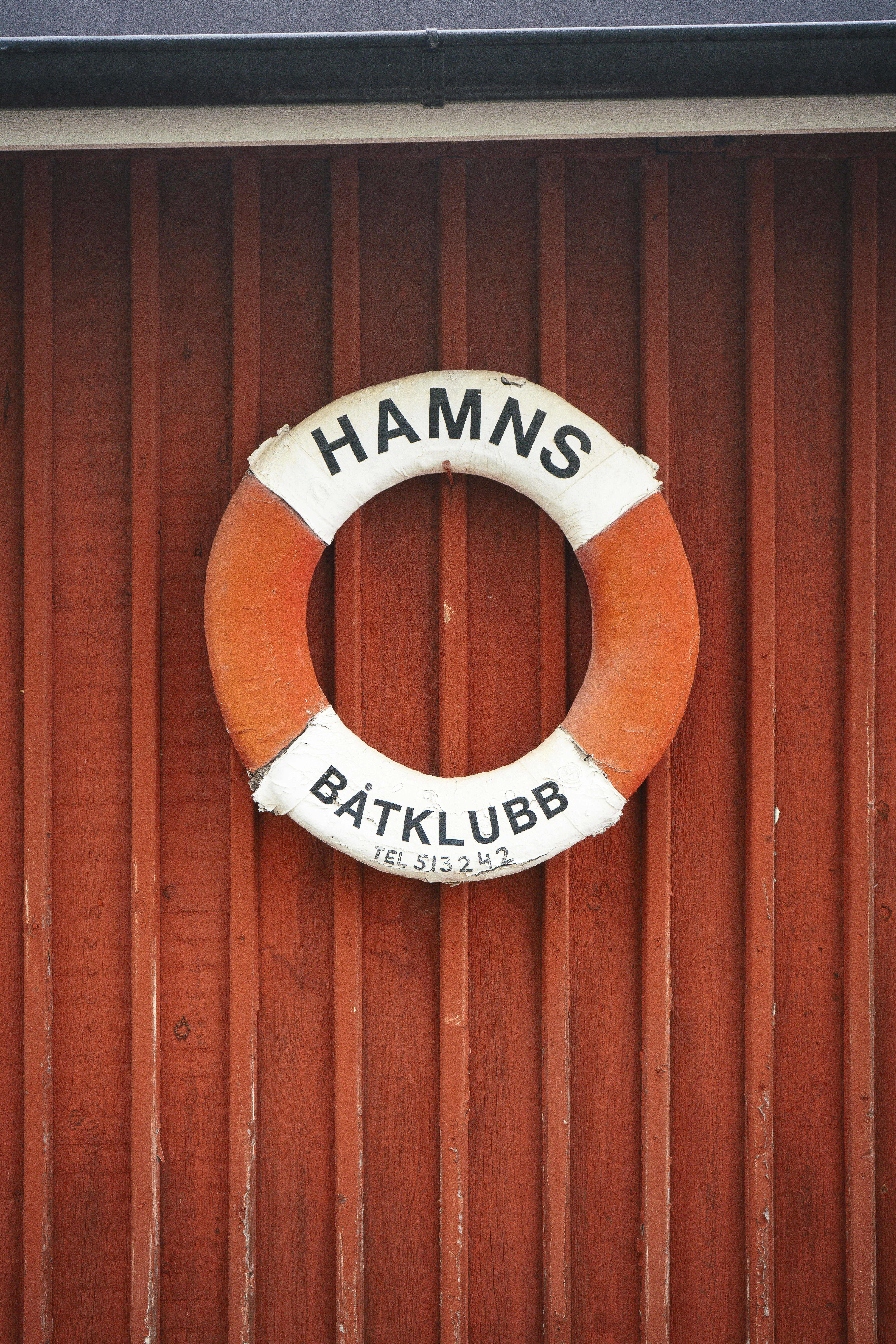 A life preserver on the side of a building photo – Free Text Image on ...