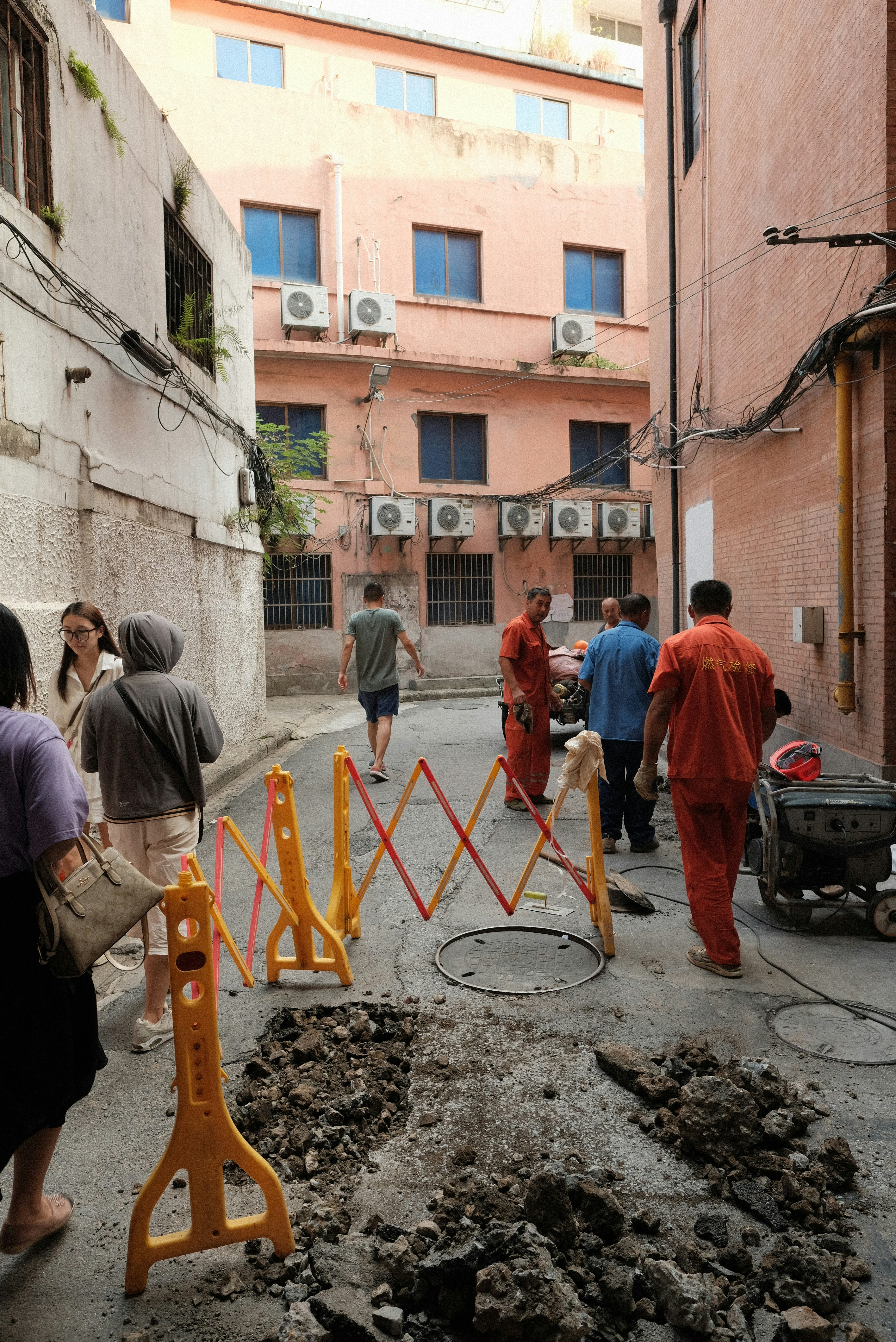 Barriers, Boots, and Brick: A Narrow Alley at Work