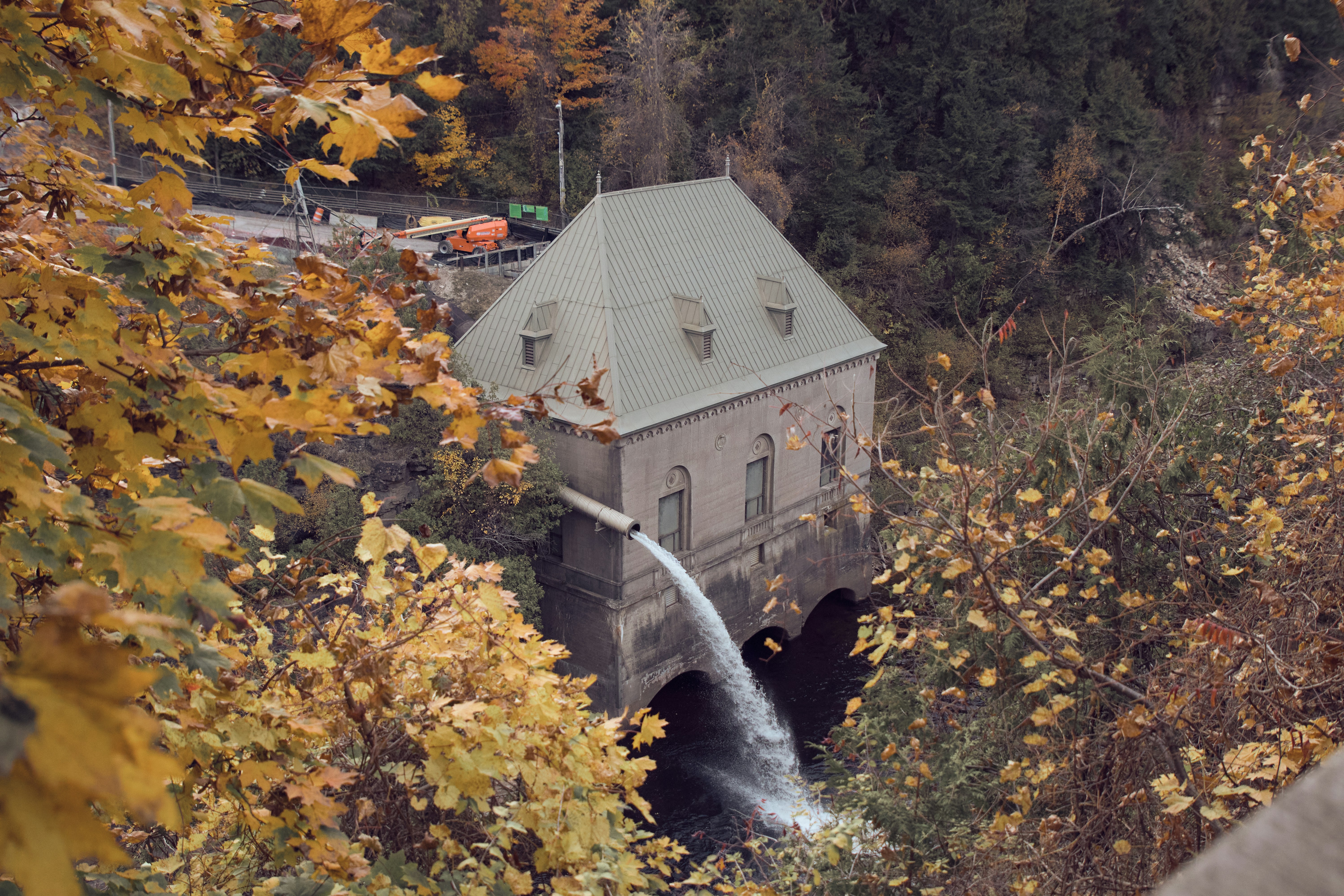 A house on a hill with a waterfall coming out of it photo – Free ...