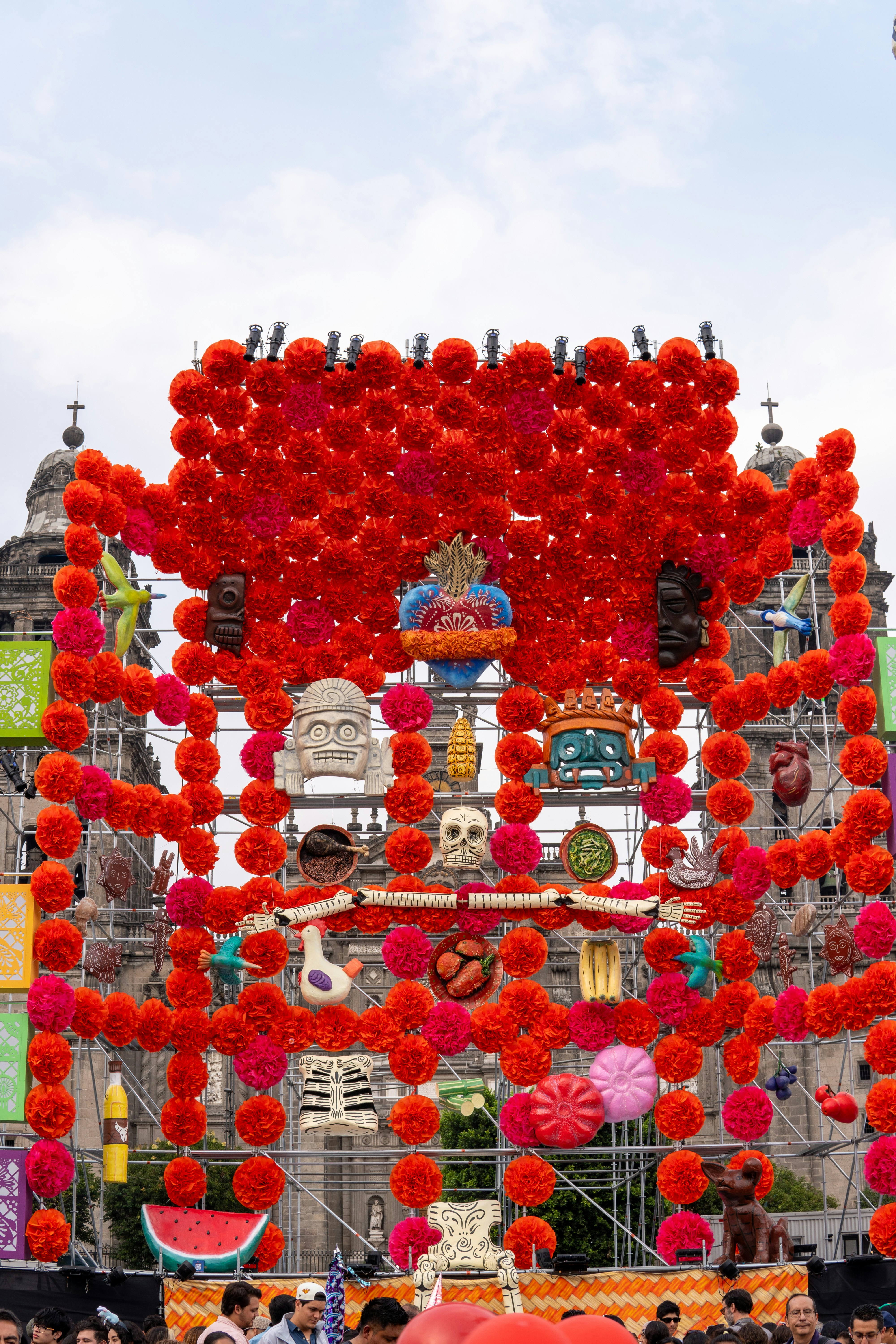 Fiery Floral Shrine: A Carnival of Red Pom-Poms and Masks
