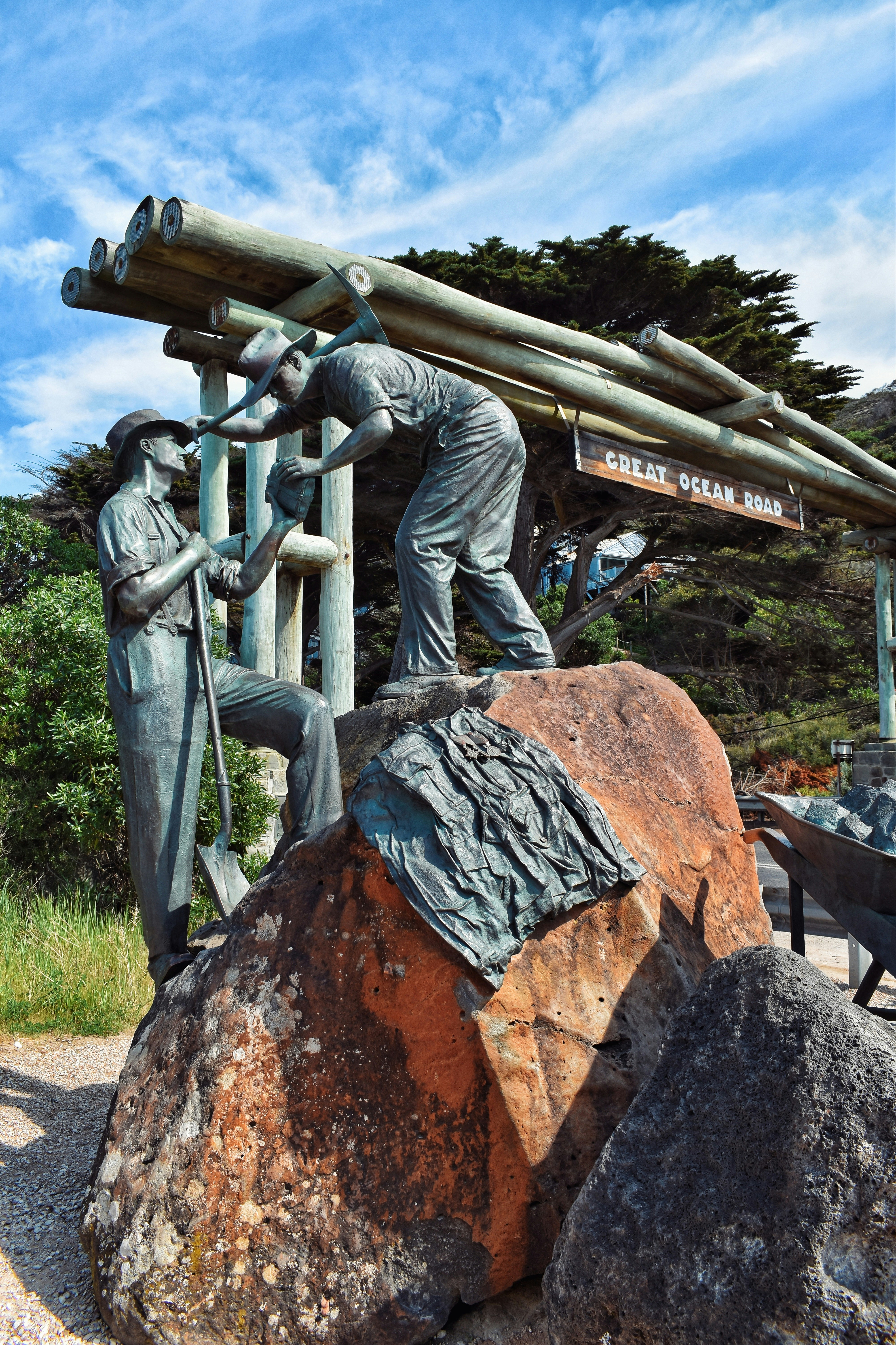 A statue of two men working on a large object