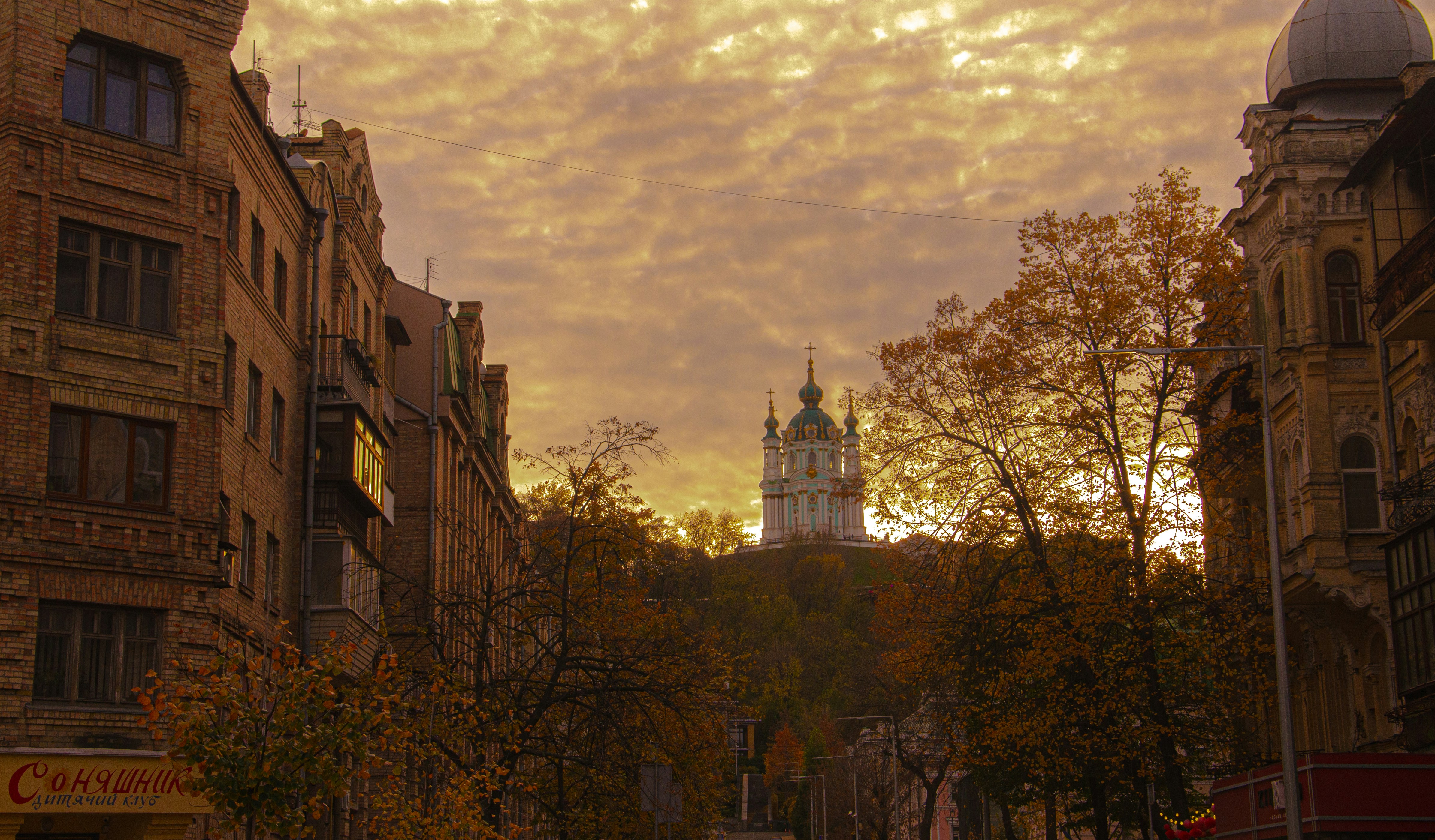 A city street with a clock tower in the distance photo – Free Kyiv ...