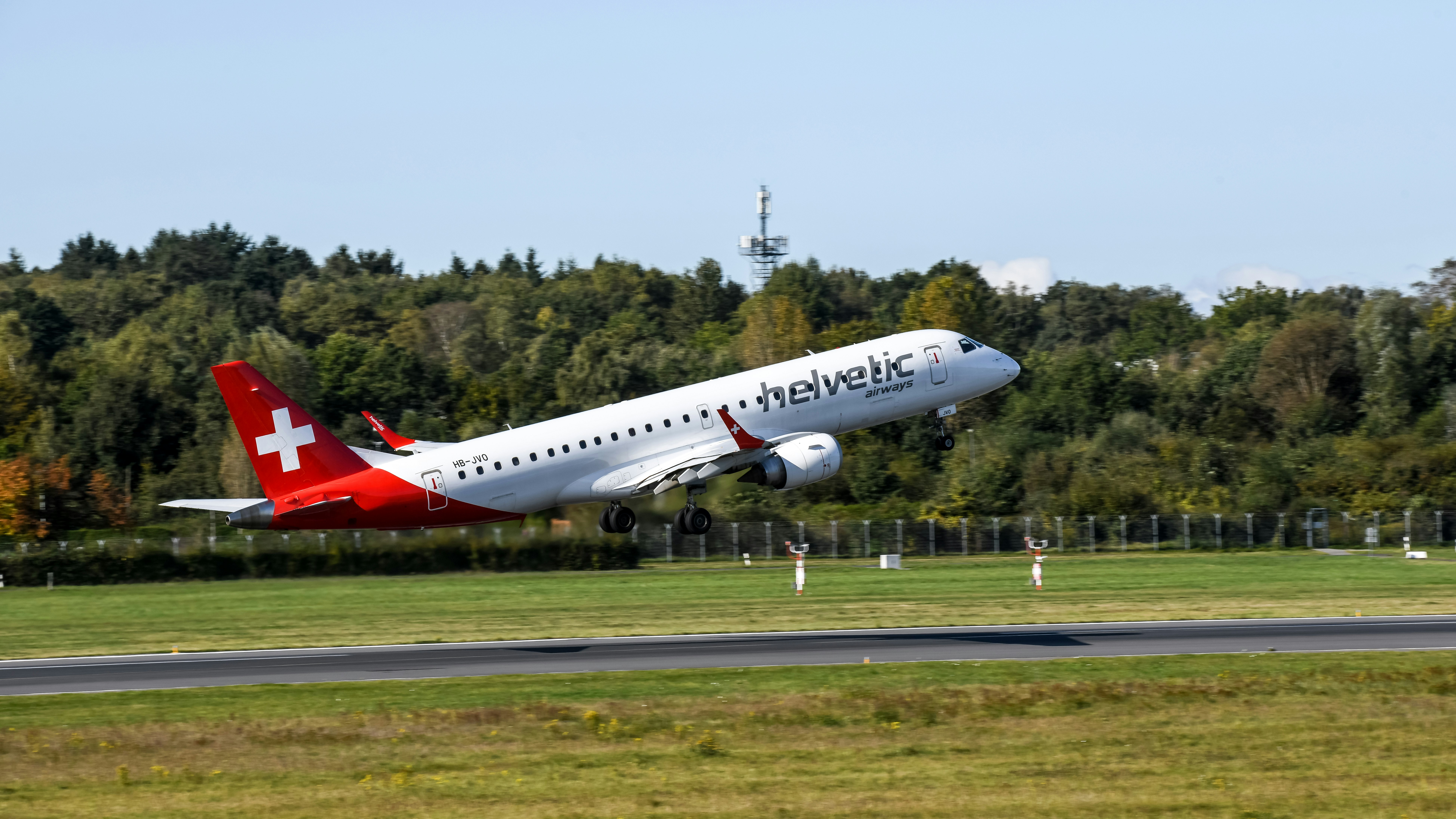 A large passenger jet taking off from an airport runway photo – Free ...