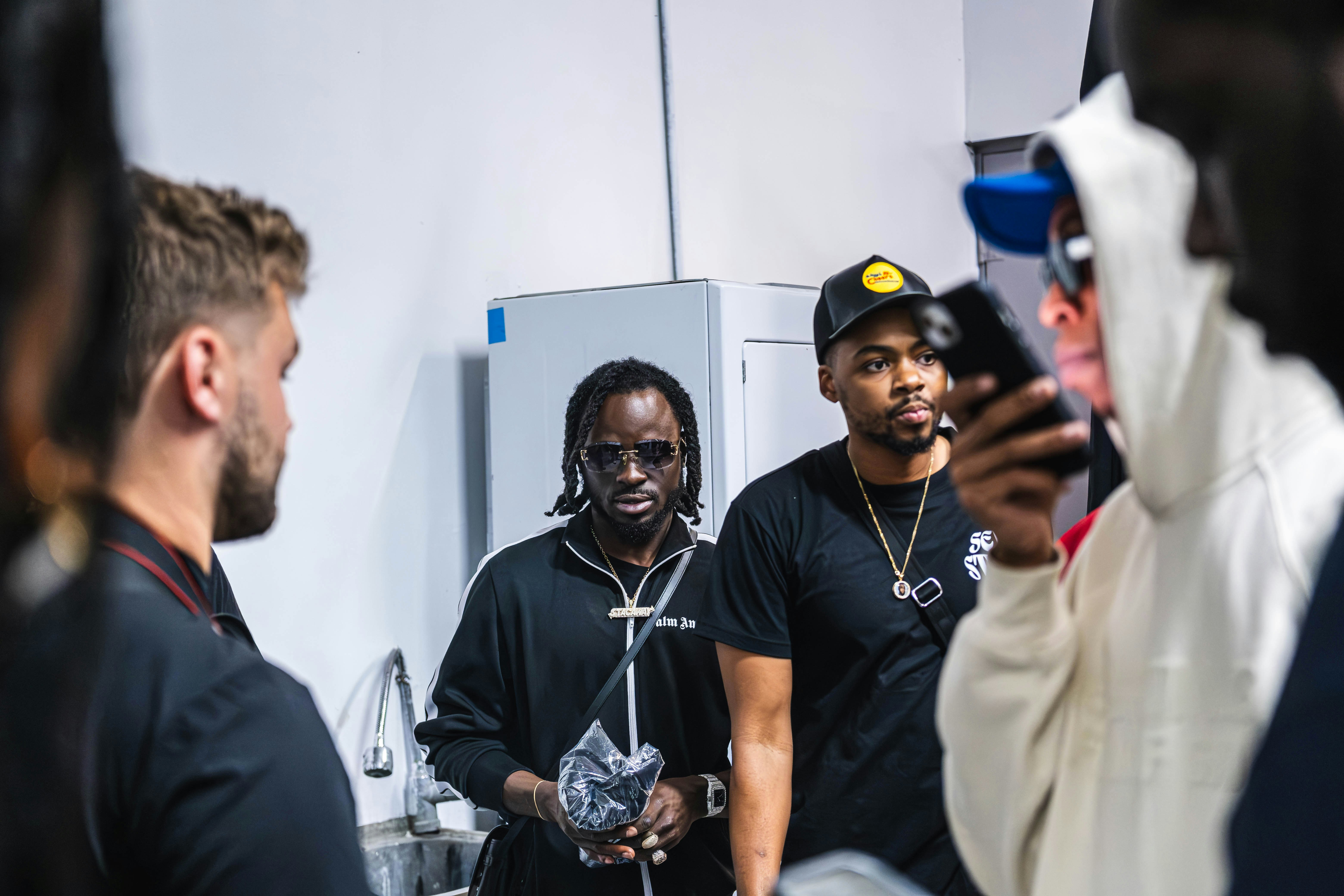A group of young men standing around each other photo – Free Toronto ...