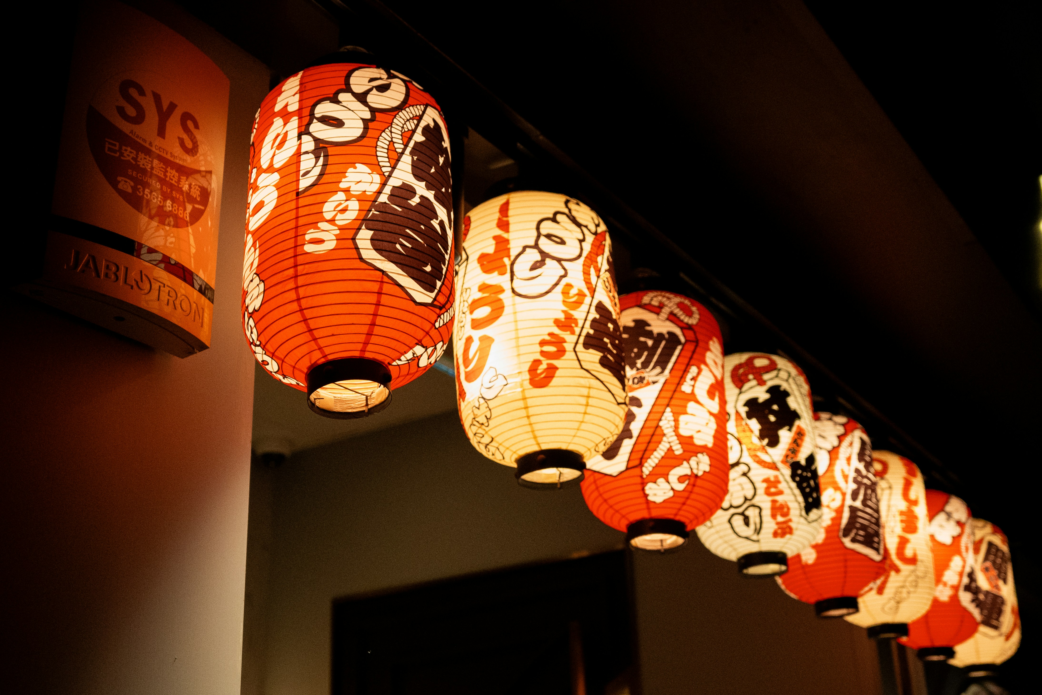 Warm Lantern Row: Paper Lamps Lighting a Dim Corridor