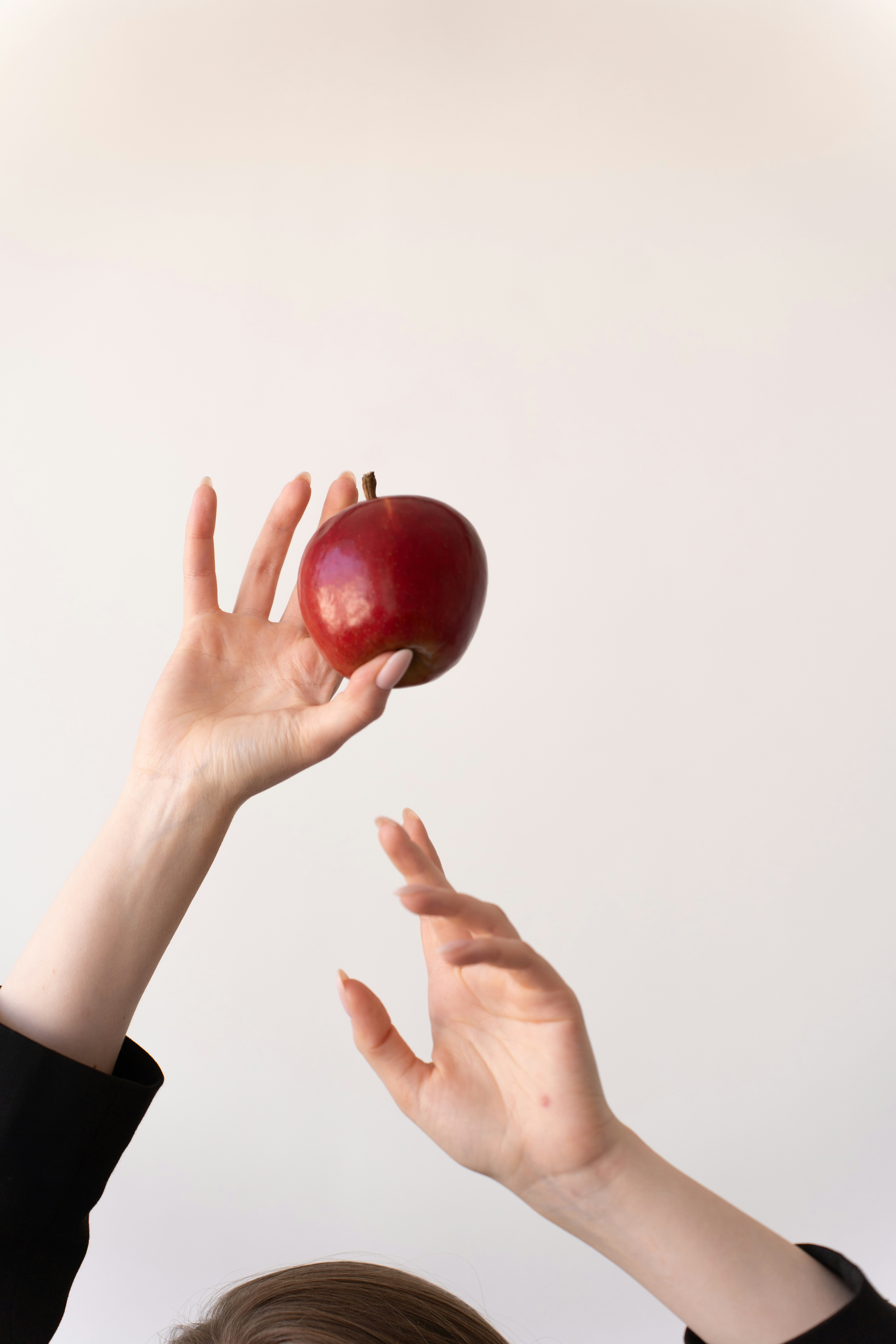 Two people reaching up to grab an apple photo – Free Apple Image on ...