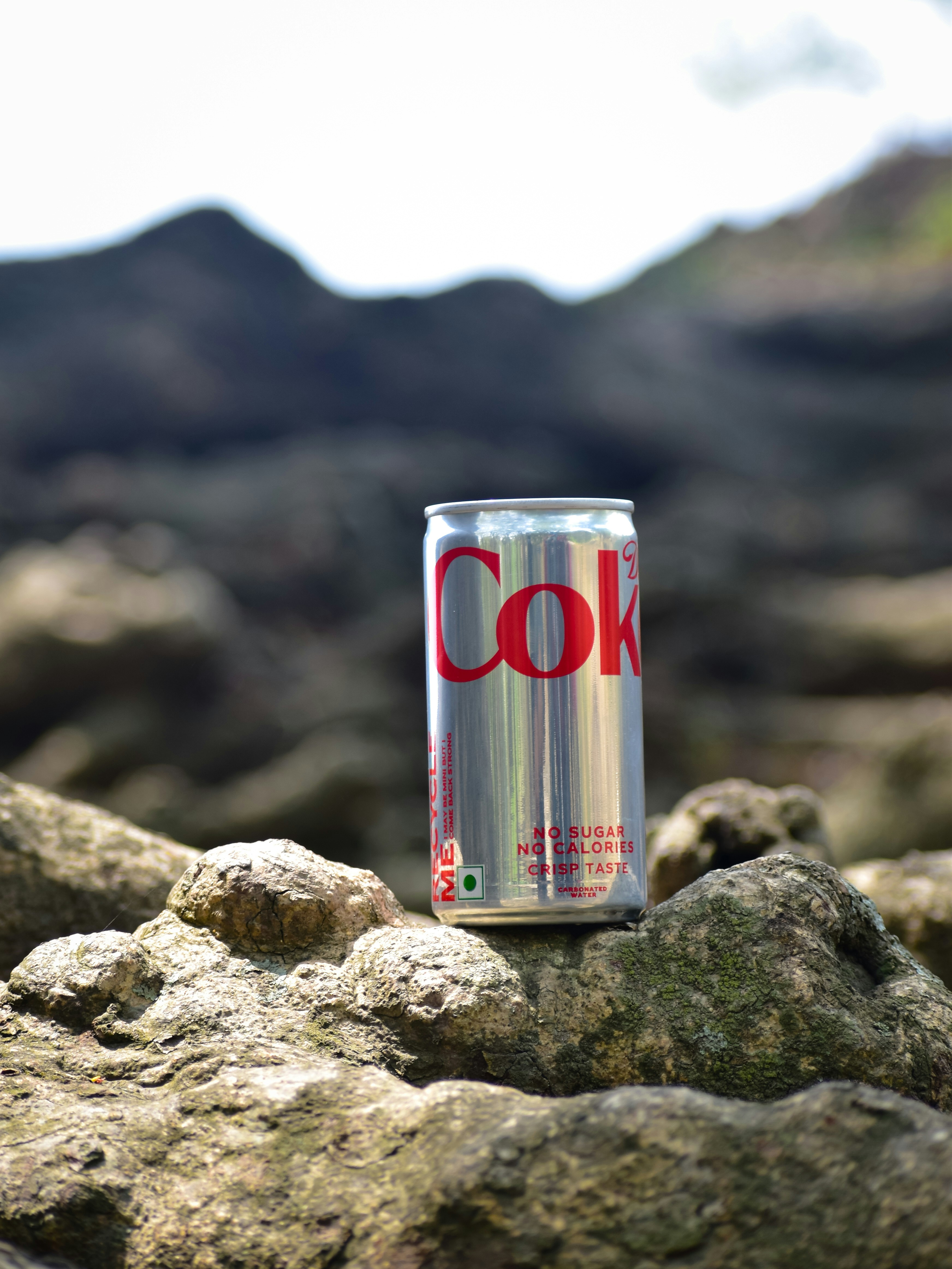 Glint on the Ridge: Coca-Cola on Weathered Lava Rocks
