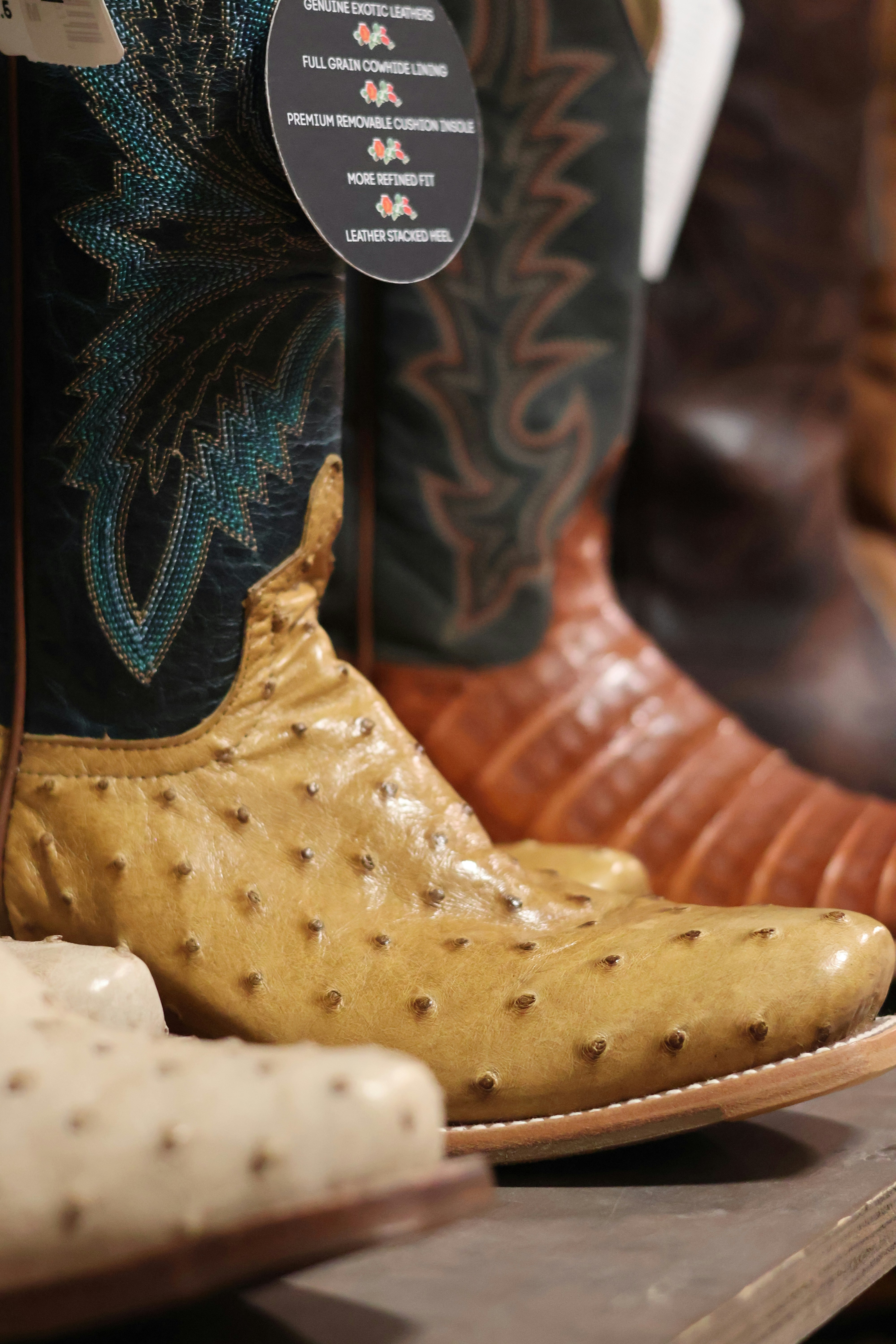 A row of cowboy boots sitting on top of a wooden shelf photo – Free ...
