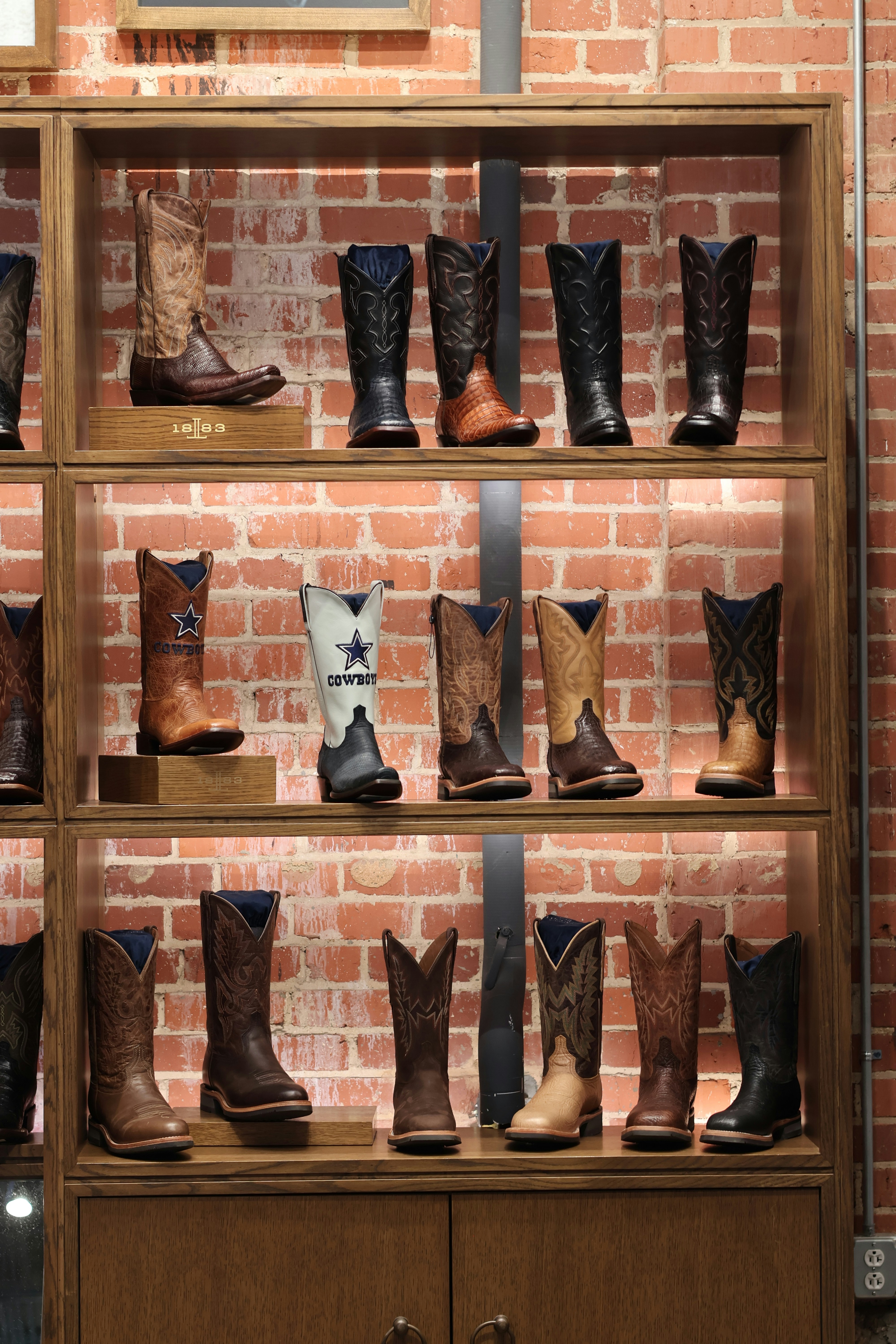 A display of cowboy boots on a wooden shelf photo – Free Boots Image on ...
