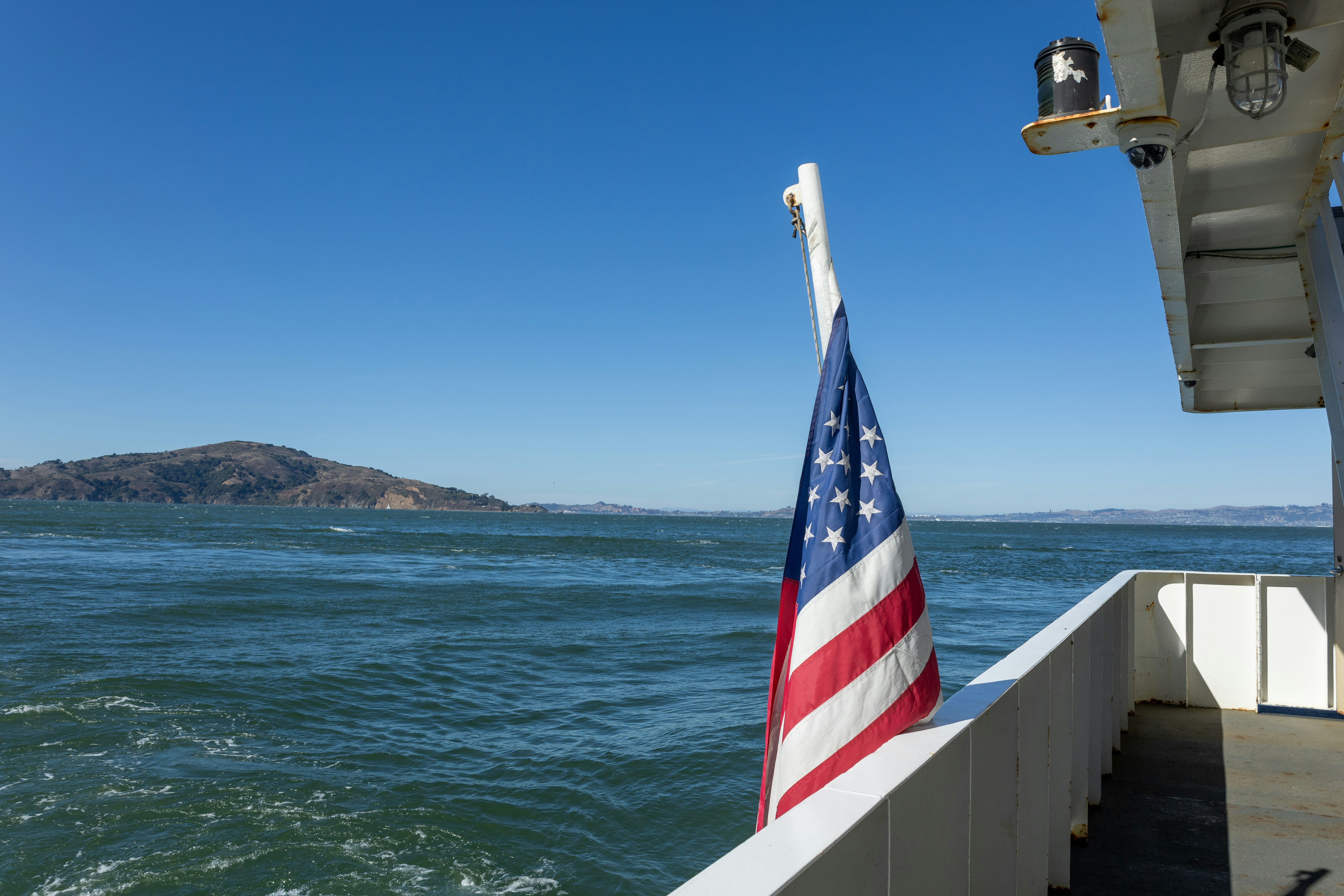 Flag at the Bow: Quiet Atlantic Horizon from the Deck