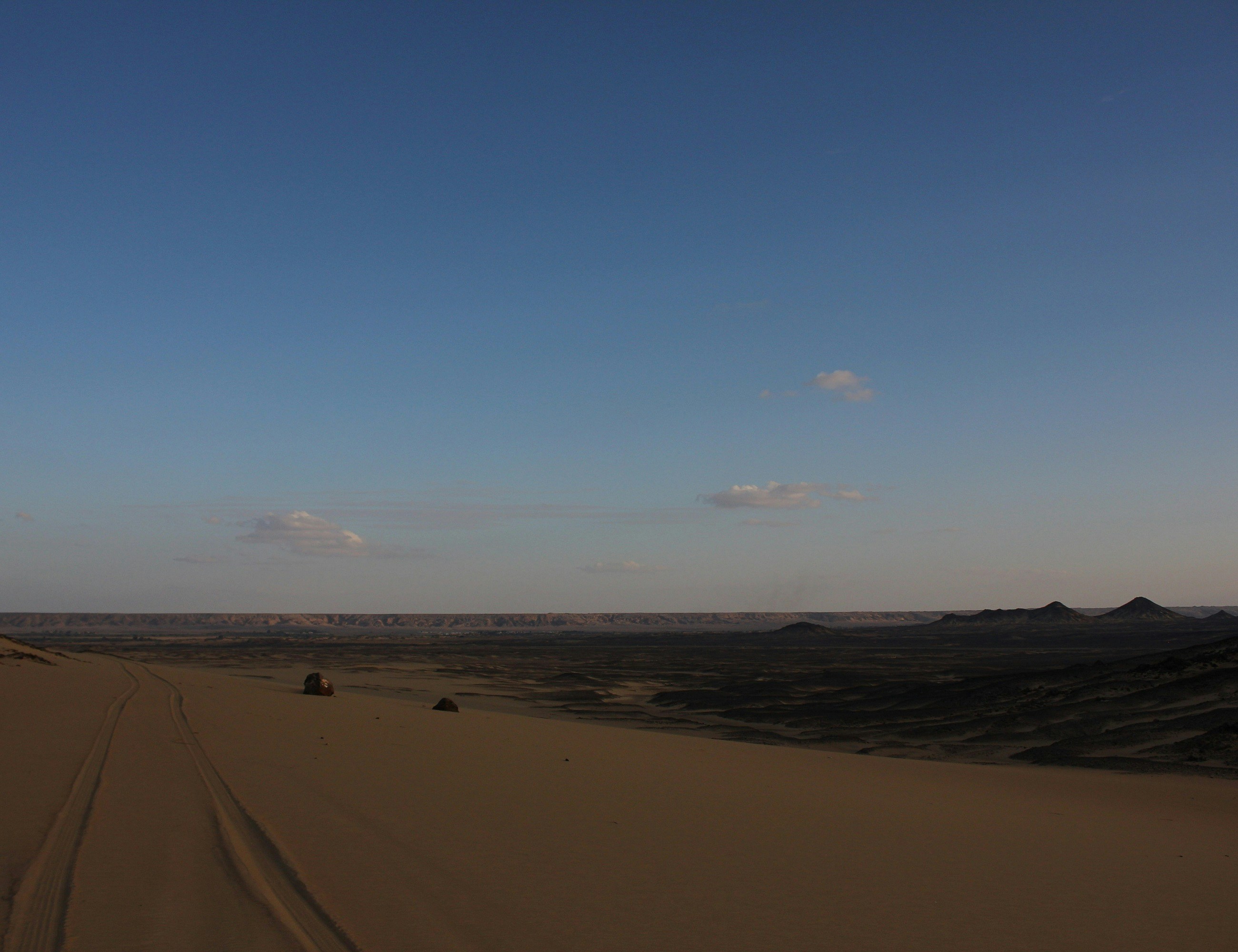 Edge Dune Highway: A Distant Vehicle on the Quiet Desert Horizon