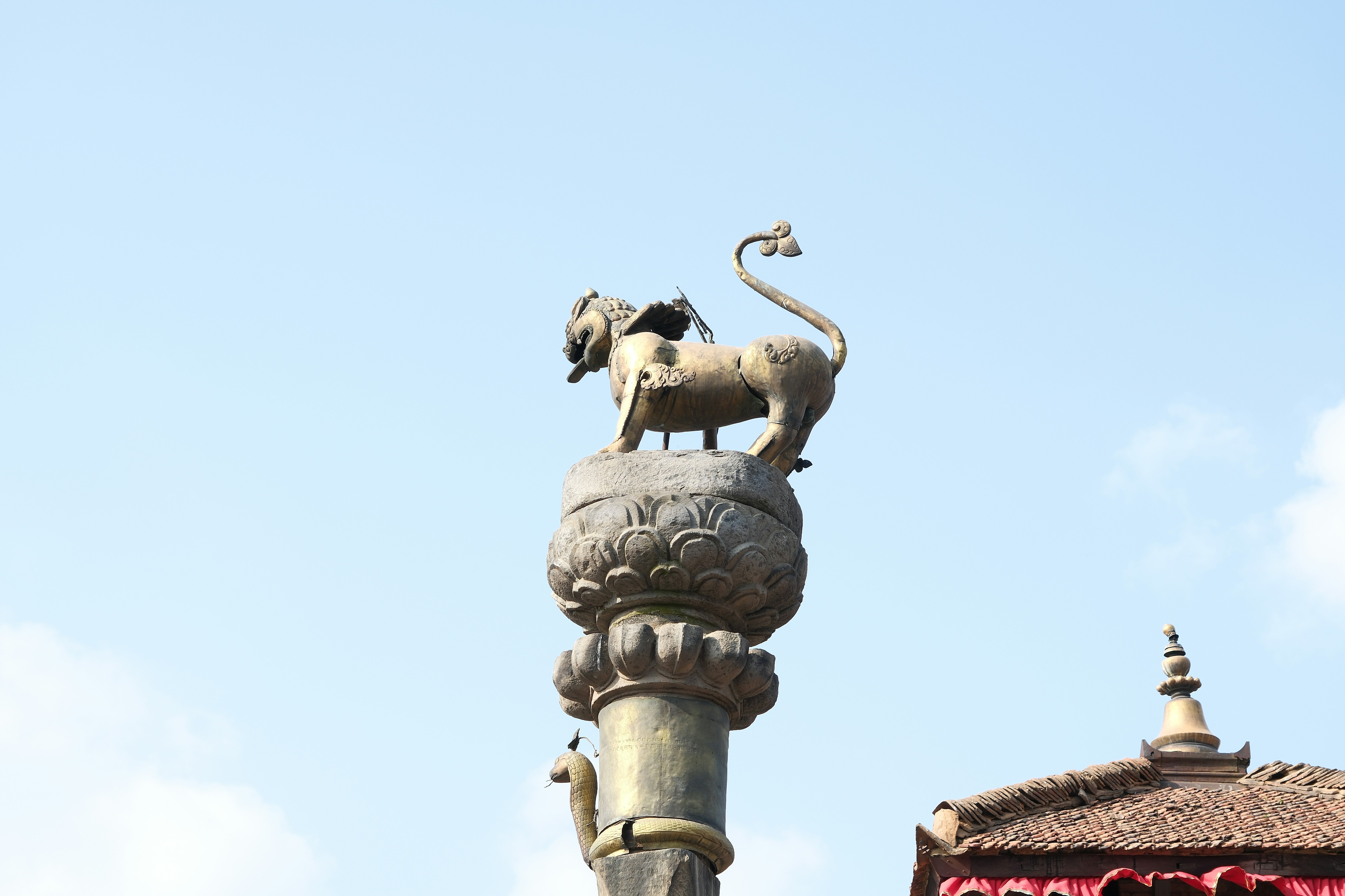 Lions at the Pinnacle: A Stone Pillar Reaching Toward the Sky