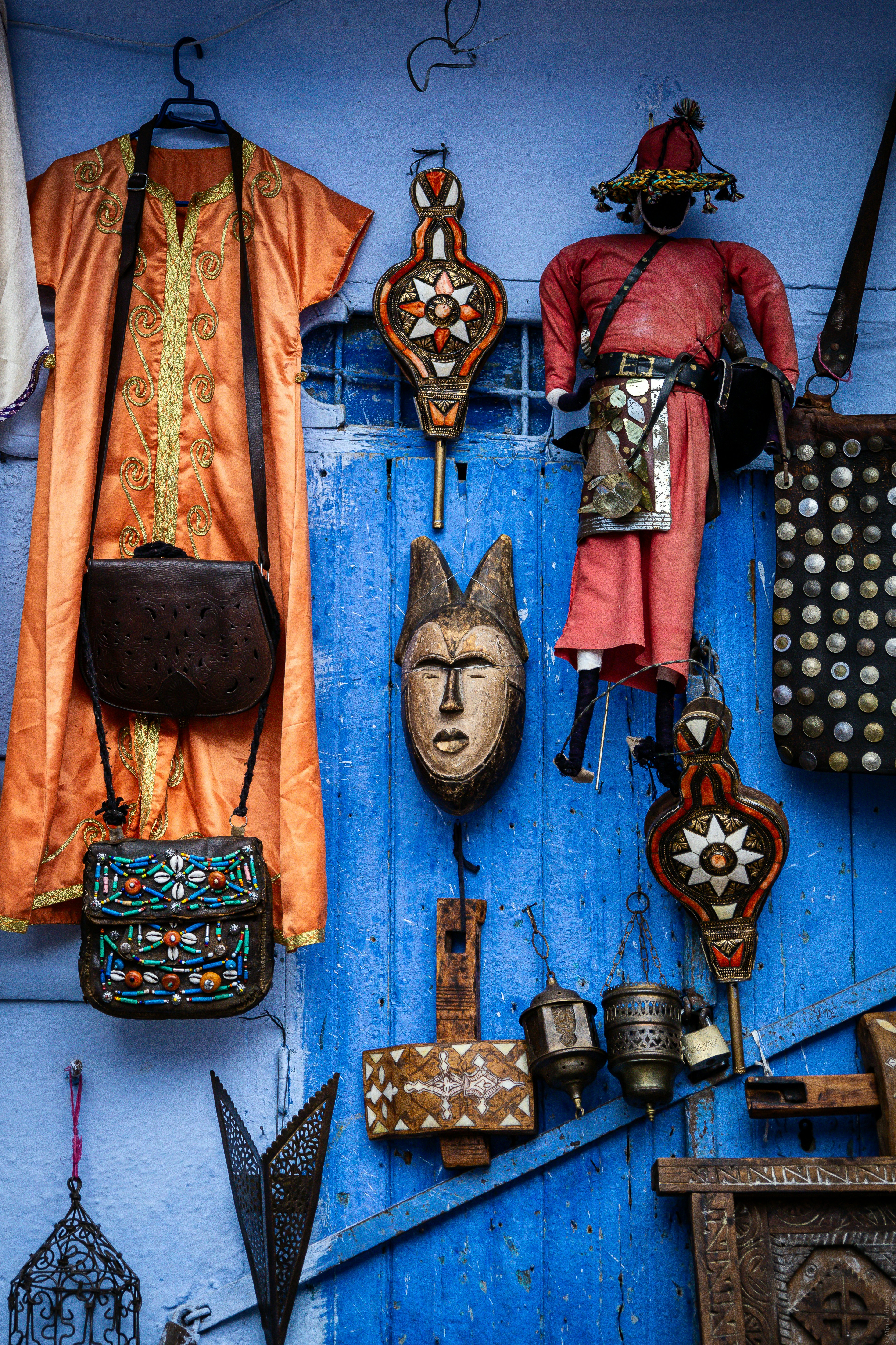 Blue Door Gallery: Colorful Ethnic Ornaments on a Rustic Wall